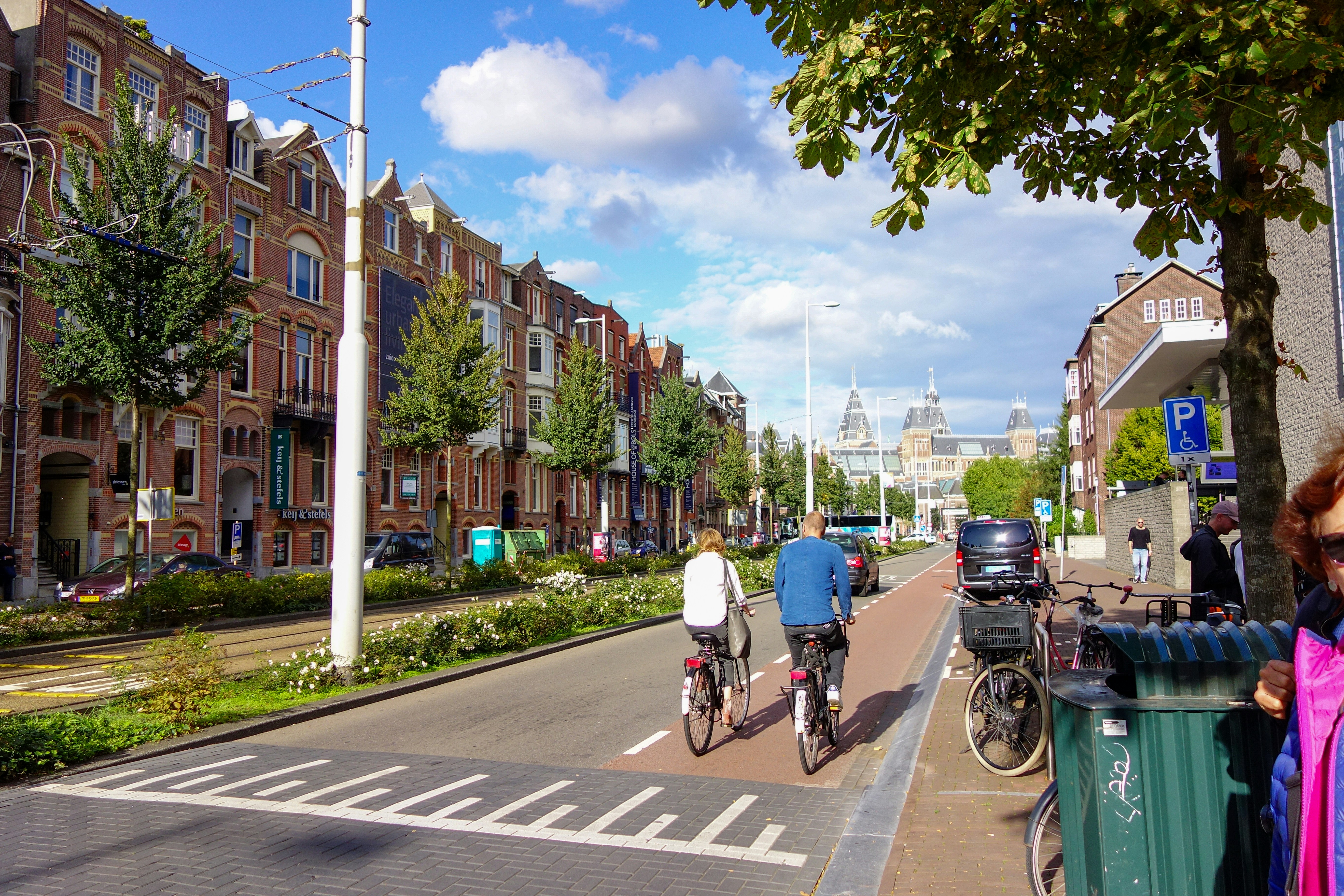 Riverside Avenue: Bicyclists Under a Bright Dutch Sky