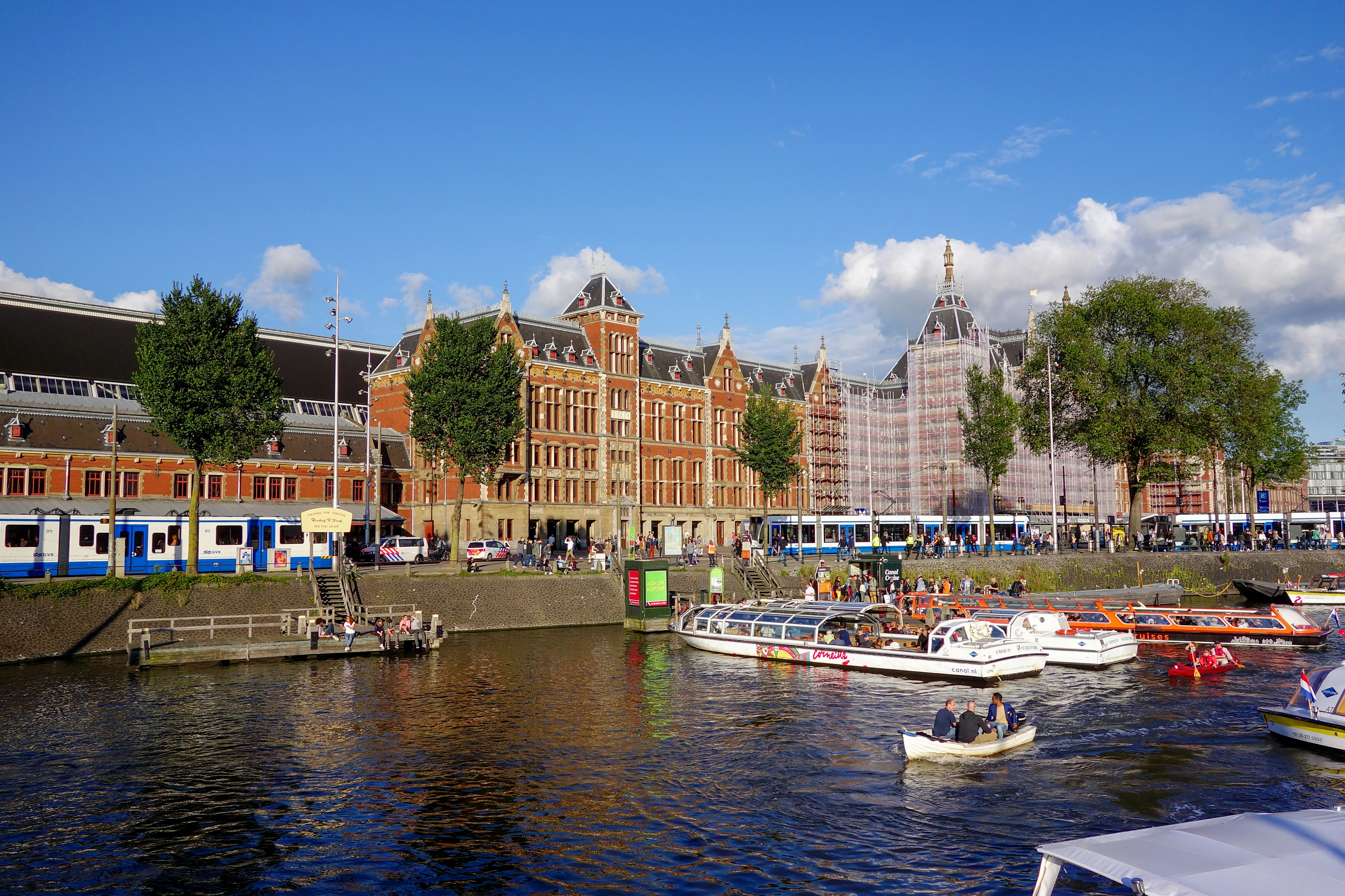 Vivid Amsterdam Waterfront: Trains, Boats, and Historic Facades
