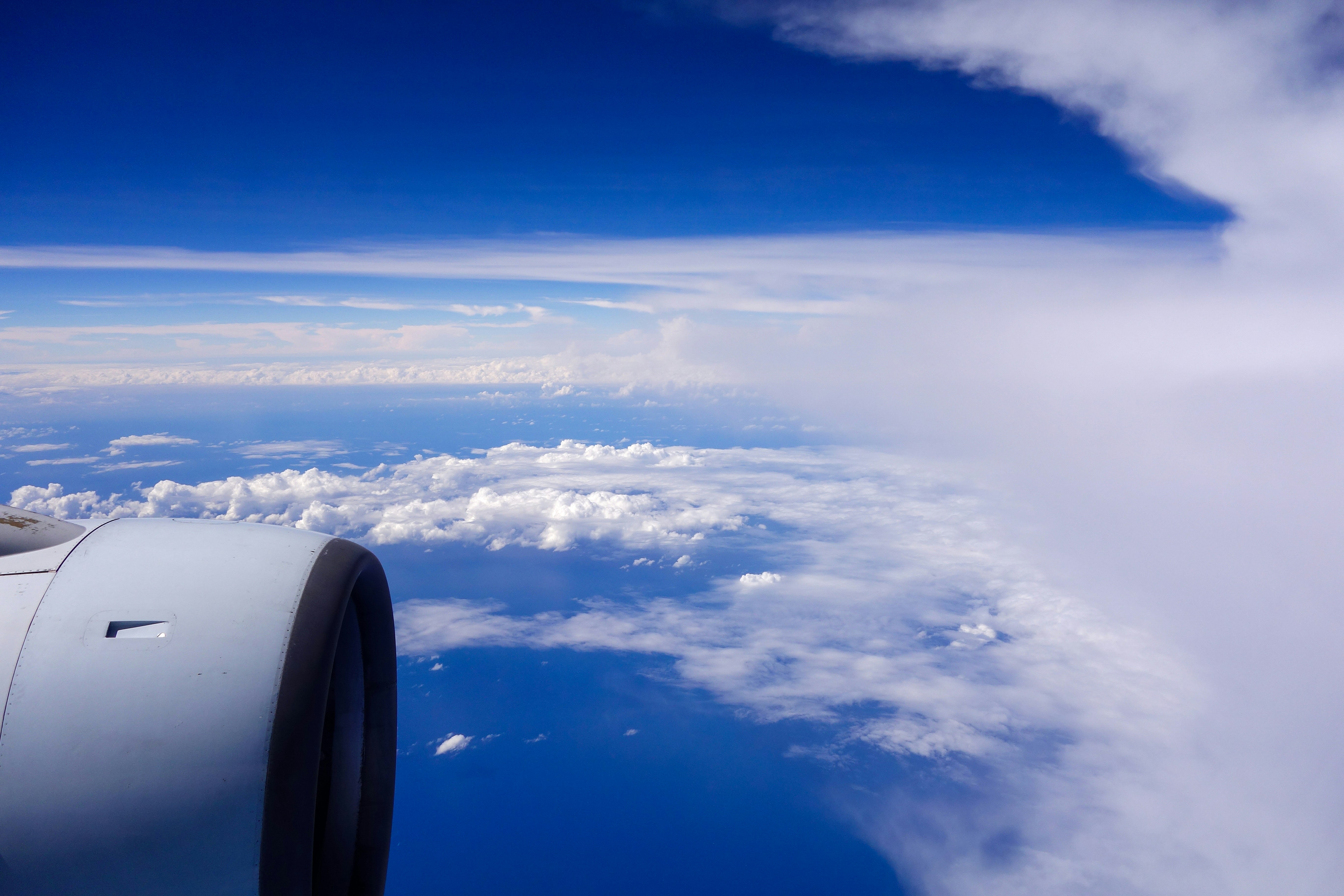 High Altitude Wing: Engine, Sky, and Clouds in Gradient Blue