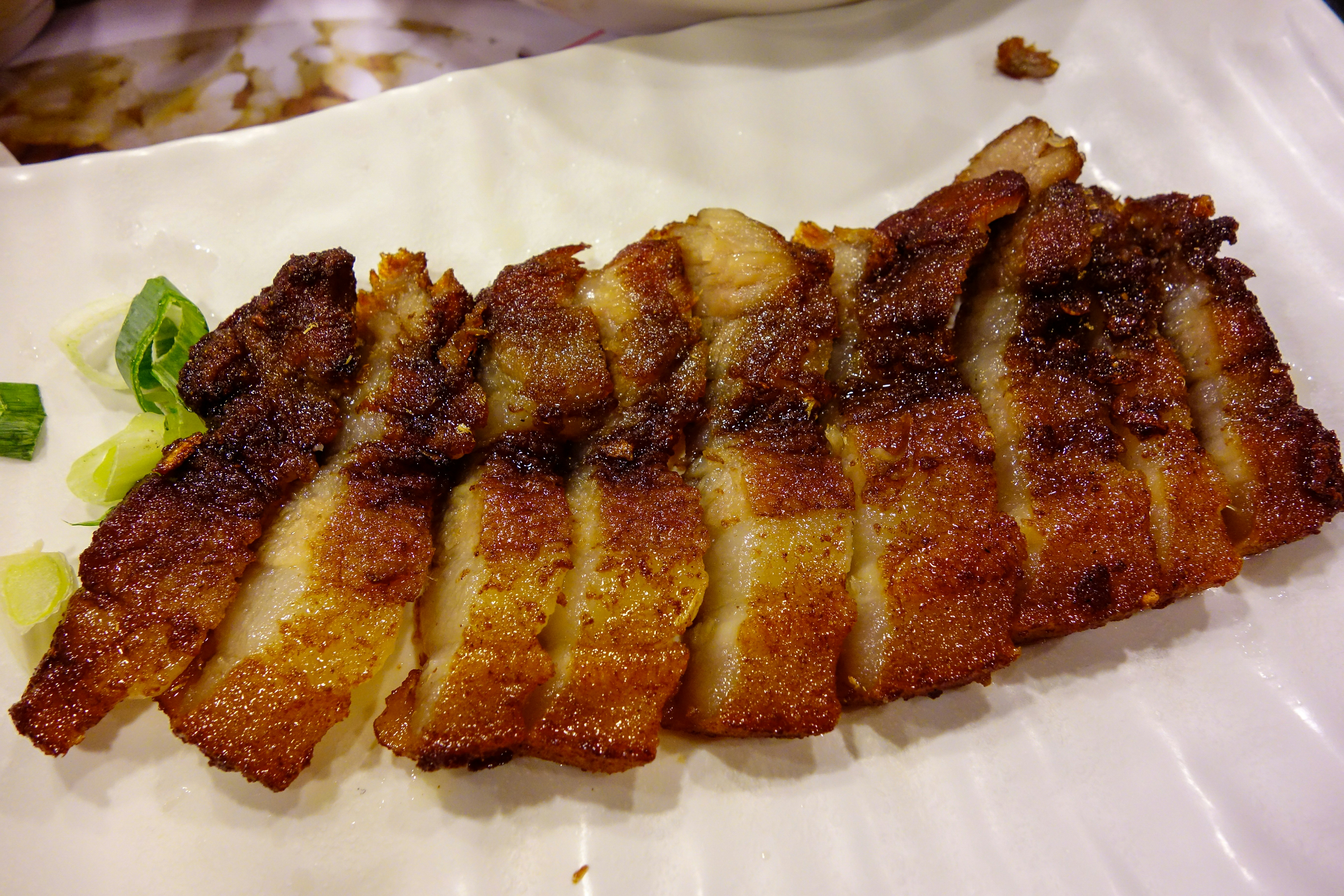 Charred Slices of Crispy Pork: A Glistening Platter of Cantonese Roast
