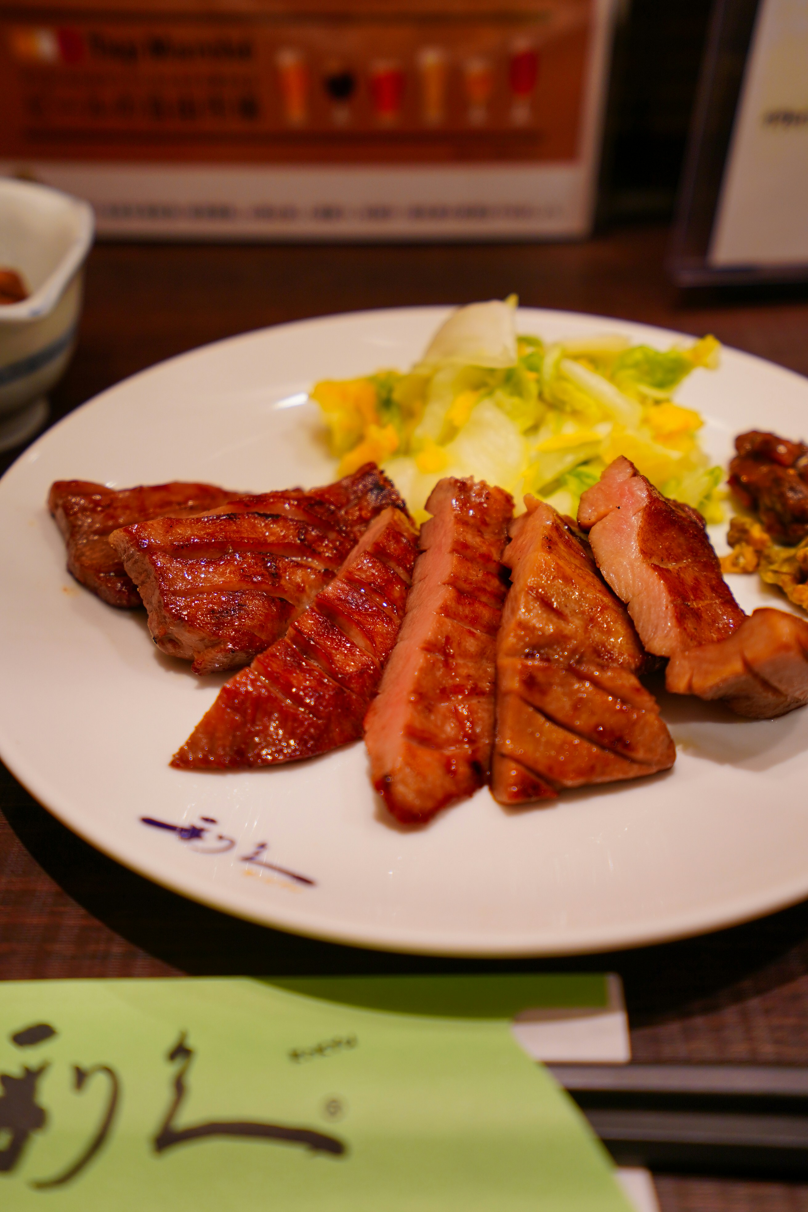 Charred Pork Tenderness on a Plate with Mixed Greens