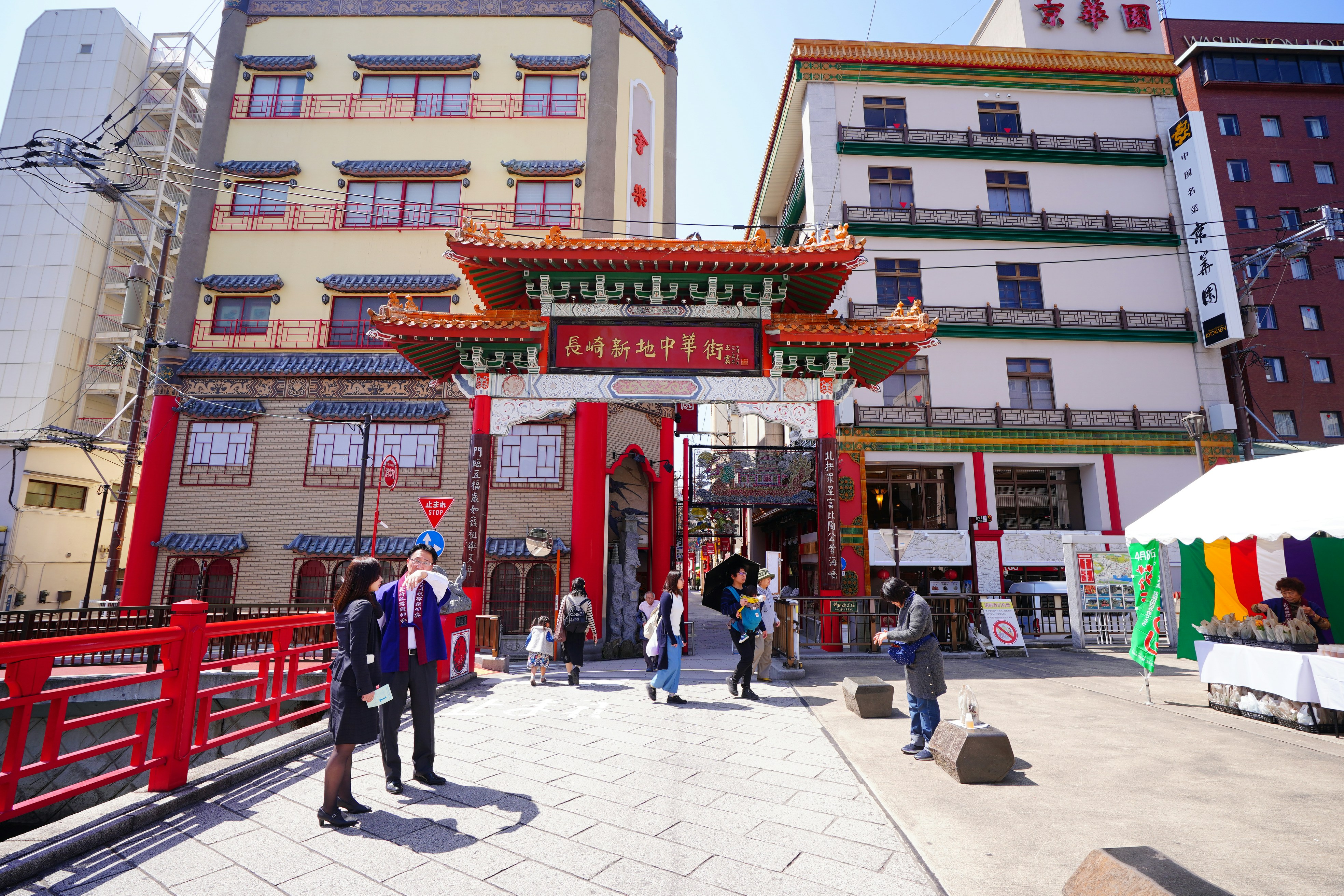 Gateway to Chinatown Courtyard: Red Archway Amid City Arcades