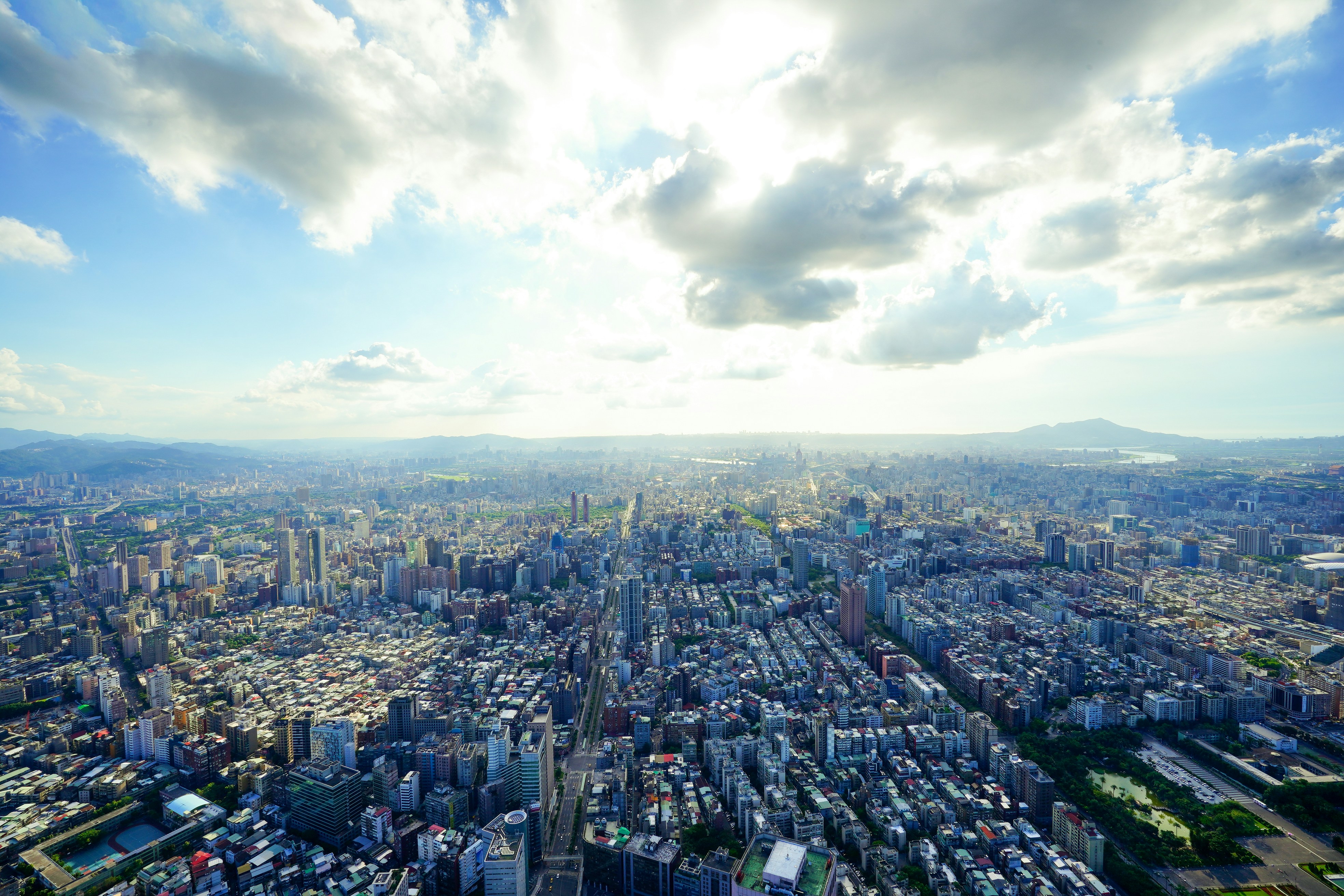 Aerial Grid: City Fractals Beneath a Cloud-Kissed Sky