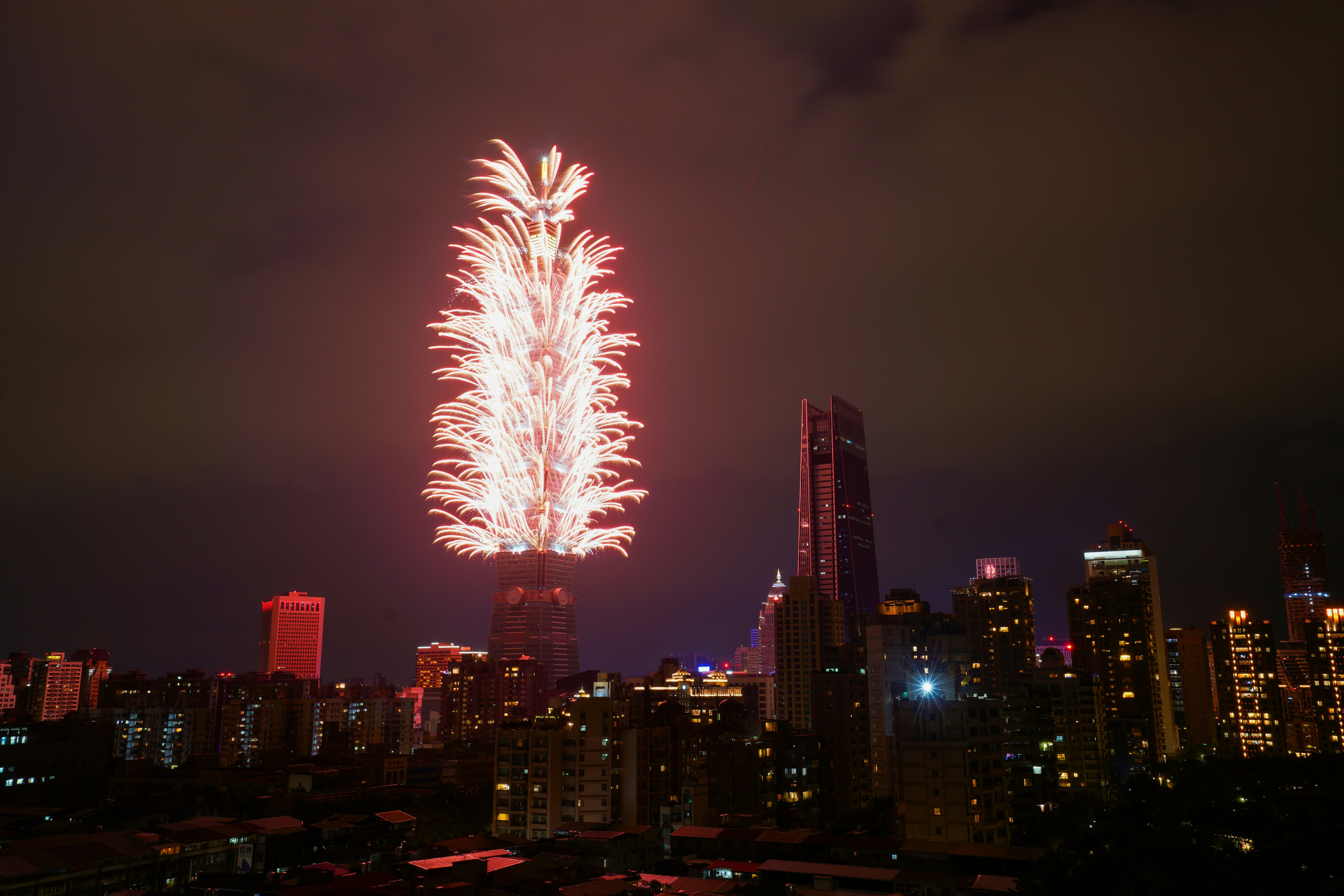 Midnight Phoenix: Firework Burst Above a City Skyline