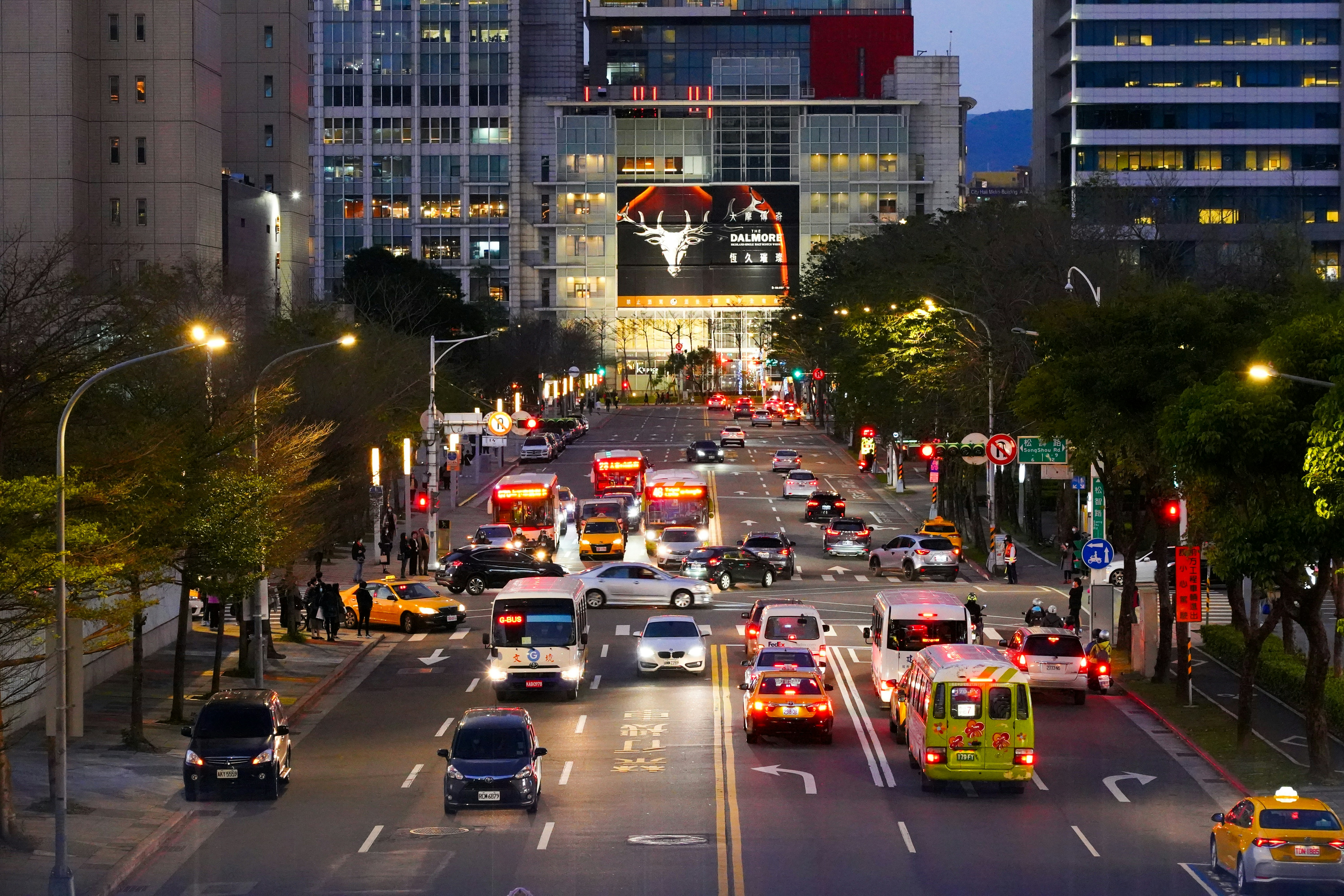 City Street Convergence: Neon Flow Through the Evening Corridor