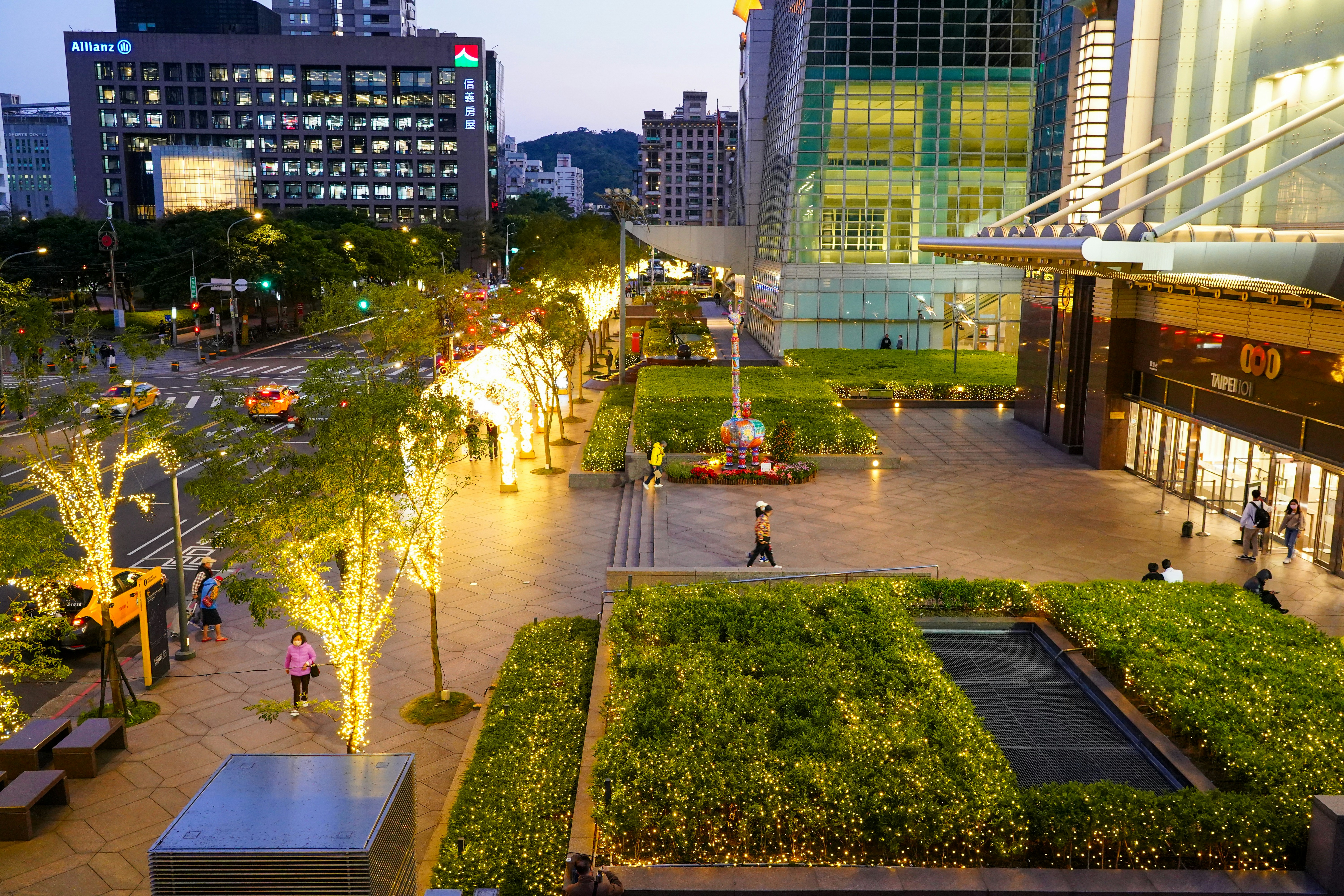 Evening Pulse: Illuminated Plaza and Glass Facades
