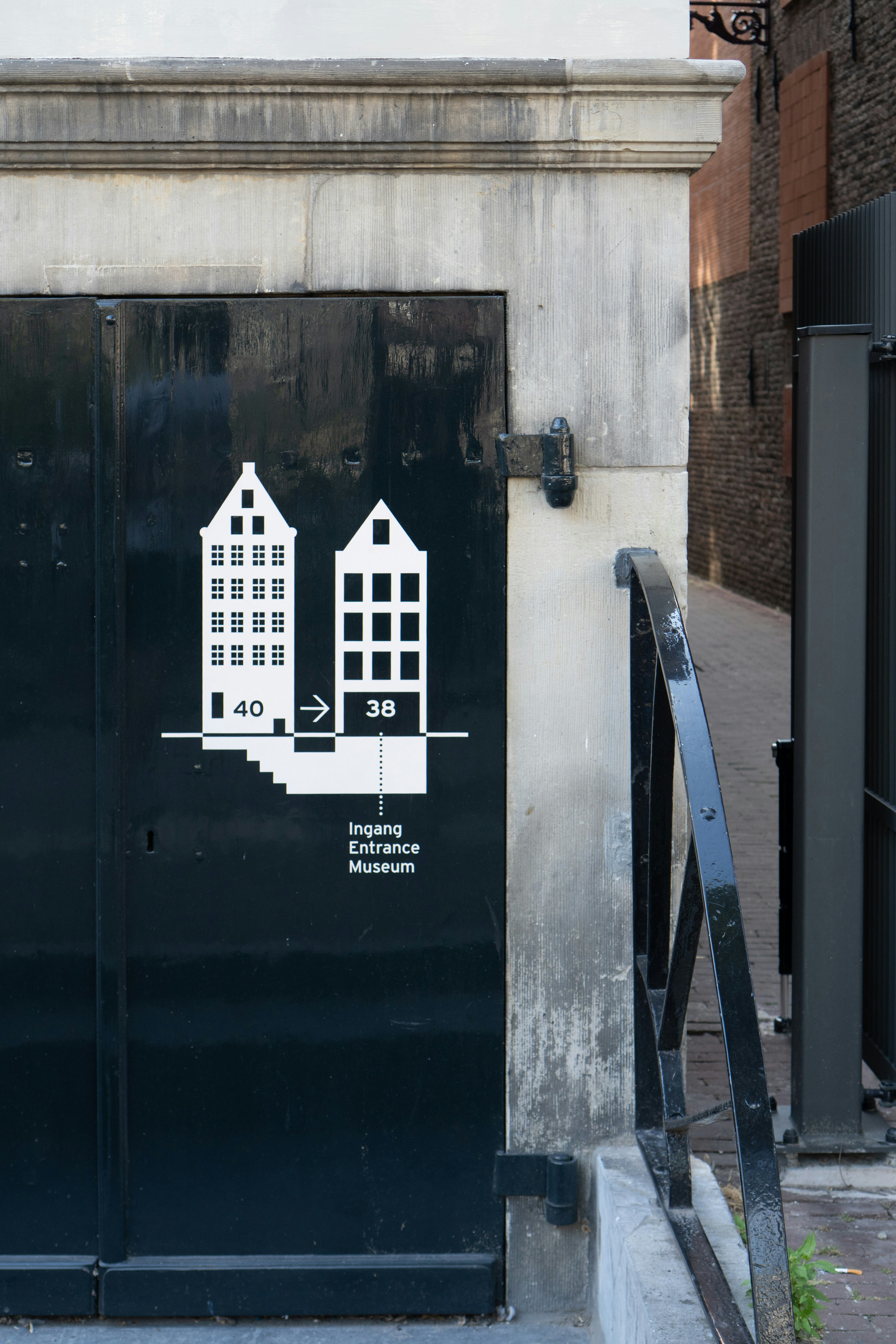 Museum Entrance Signage on a Weathered Black Doorway