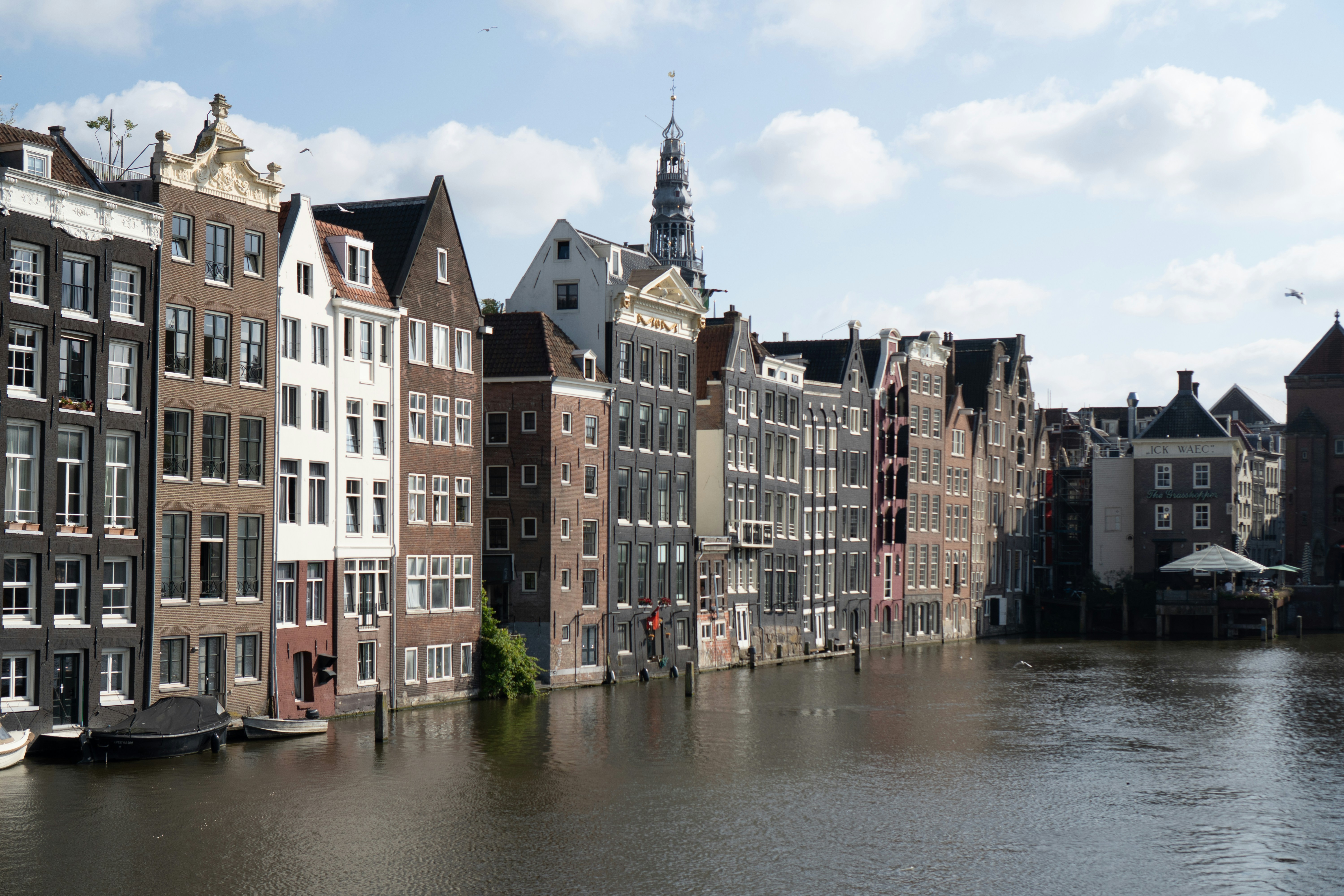 Row of Dutch-style Canal Homes Reflecting on a Calm Channel