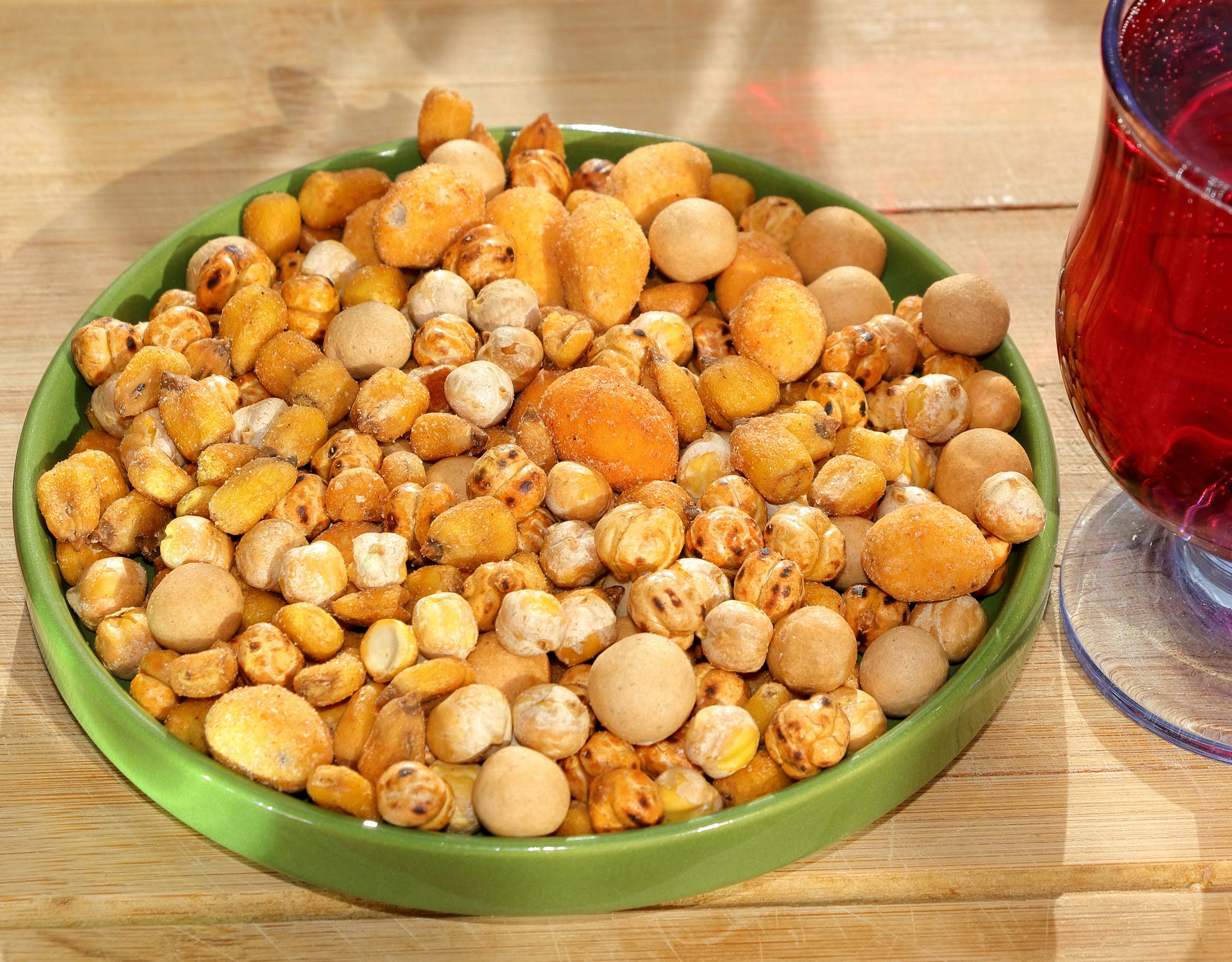 Sunlit Snack Bowl: Mixed Nuts on a Wooden Table