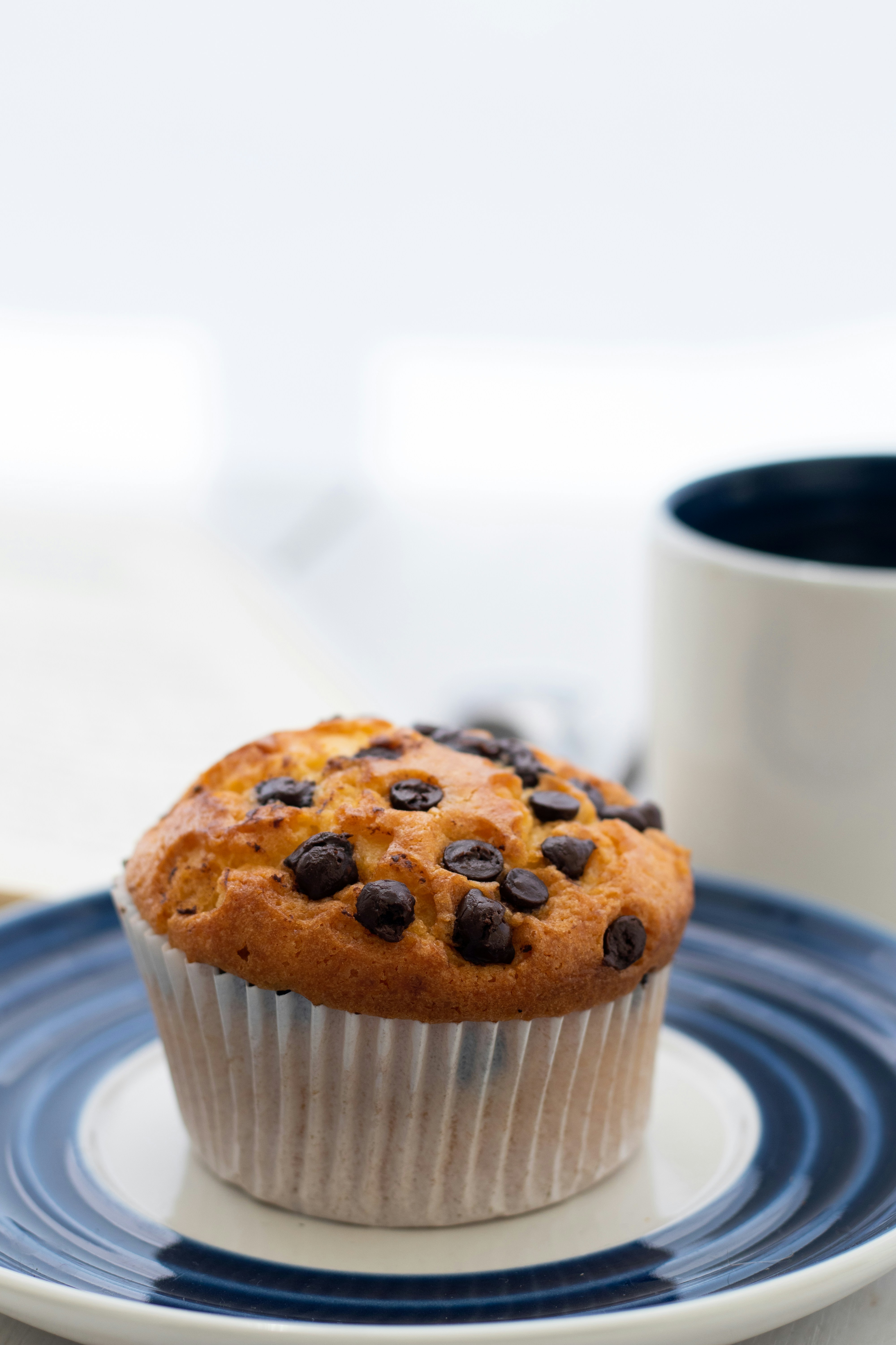 Chocolate Chip Cookie Muffin on a Blue-Rim Plate with Coffee
