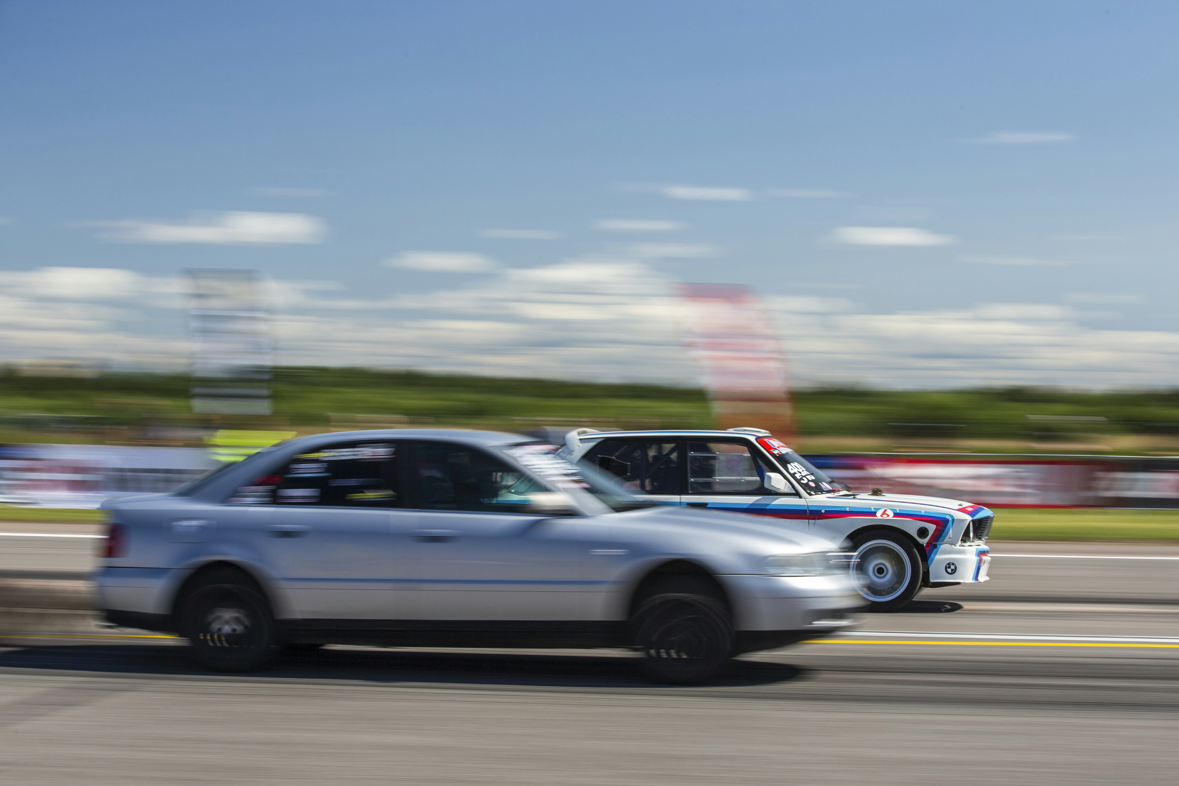Blur of Velocity: Silver Sedan and Racing Pickup in a Moving Drift