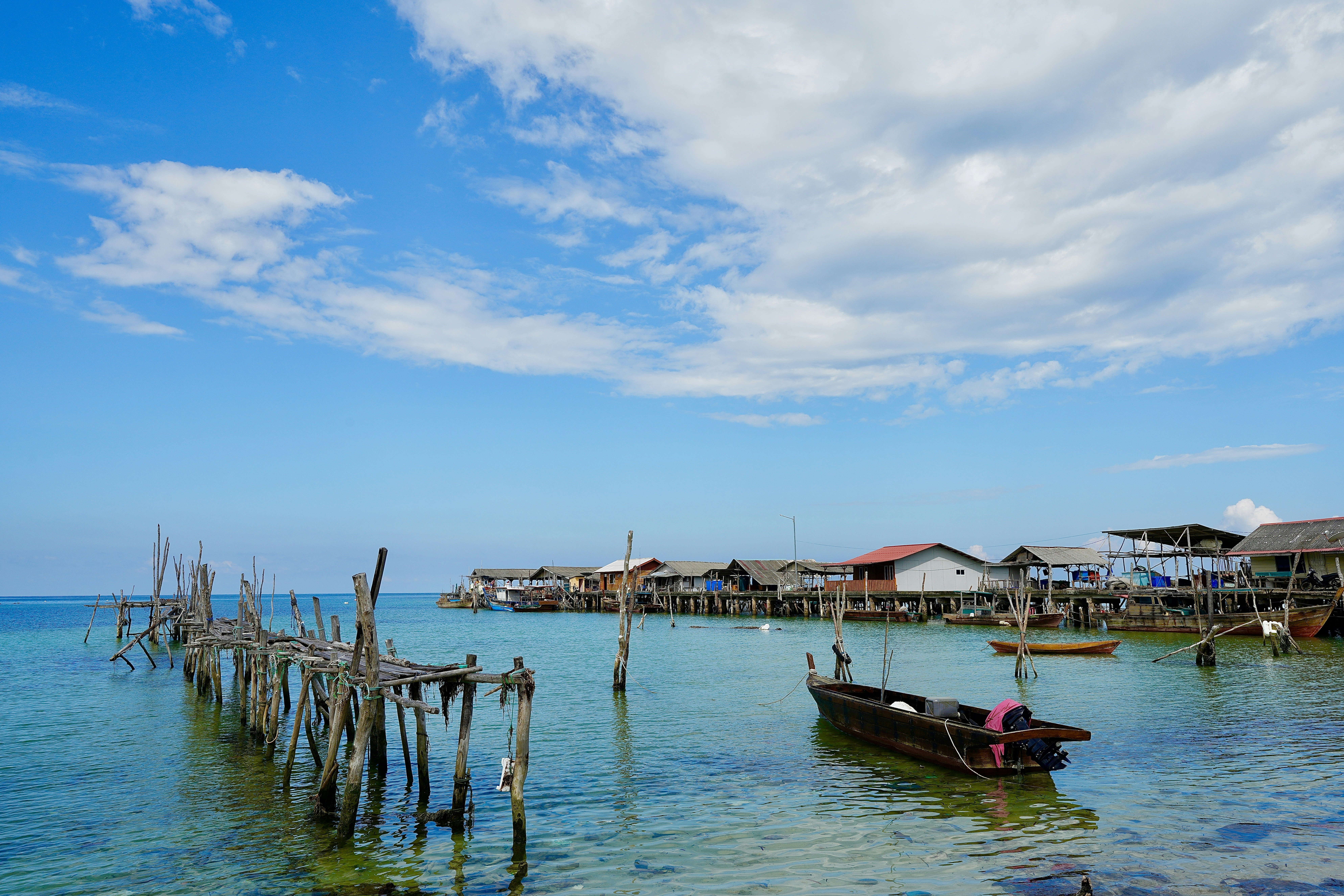 Floating Village Echoes: Boats, Timber, and a Blue Horizon