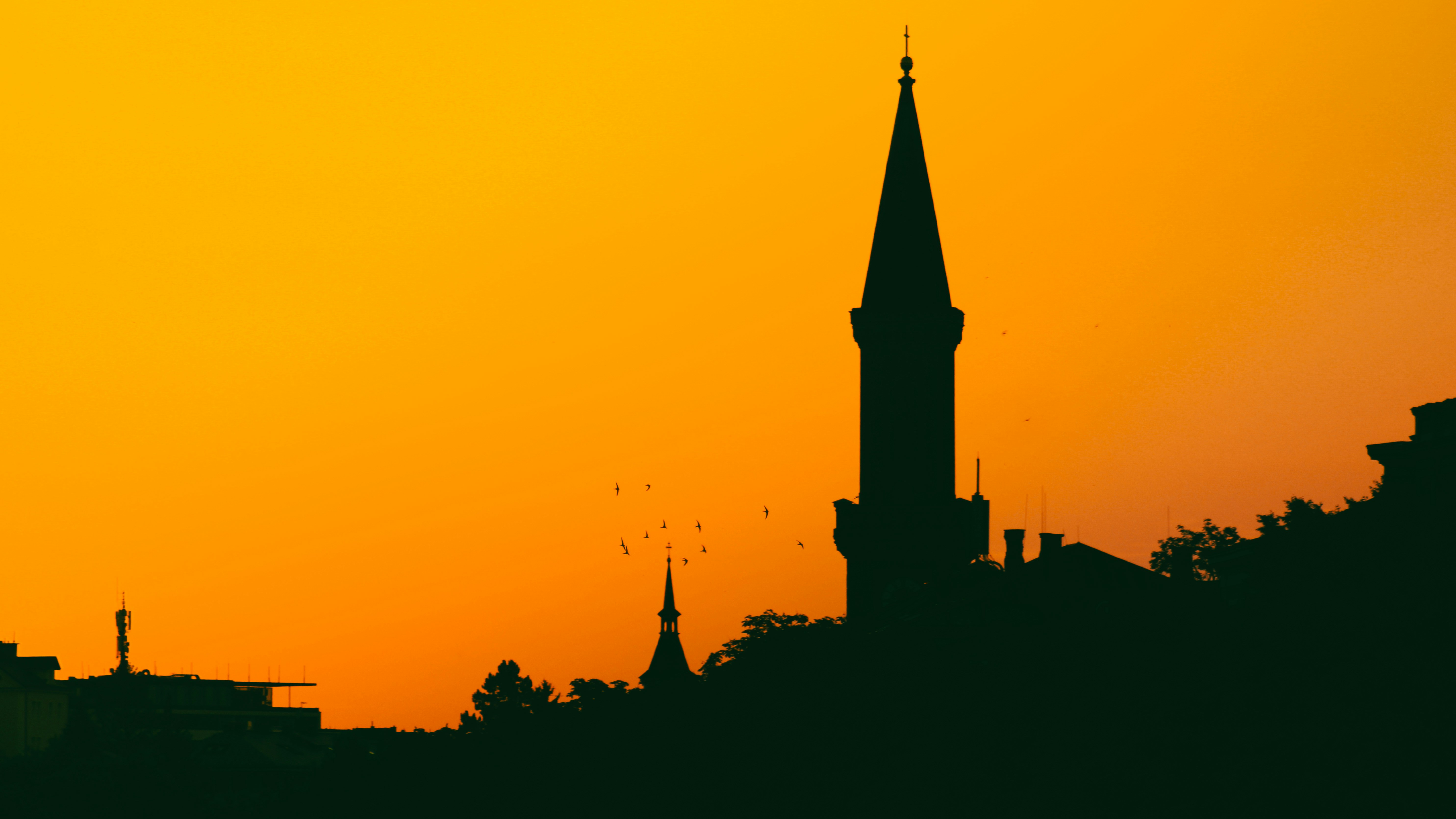 Silhouetted Spire At Dusk Over Quiet Horizon