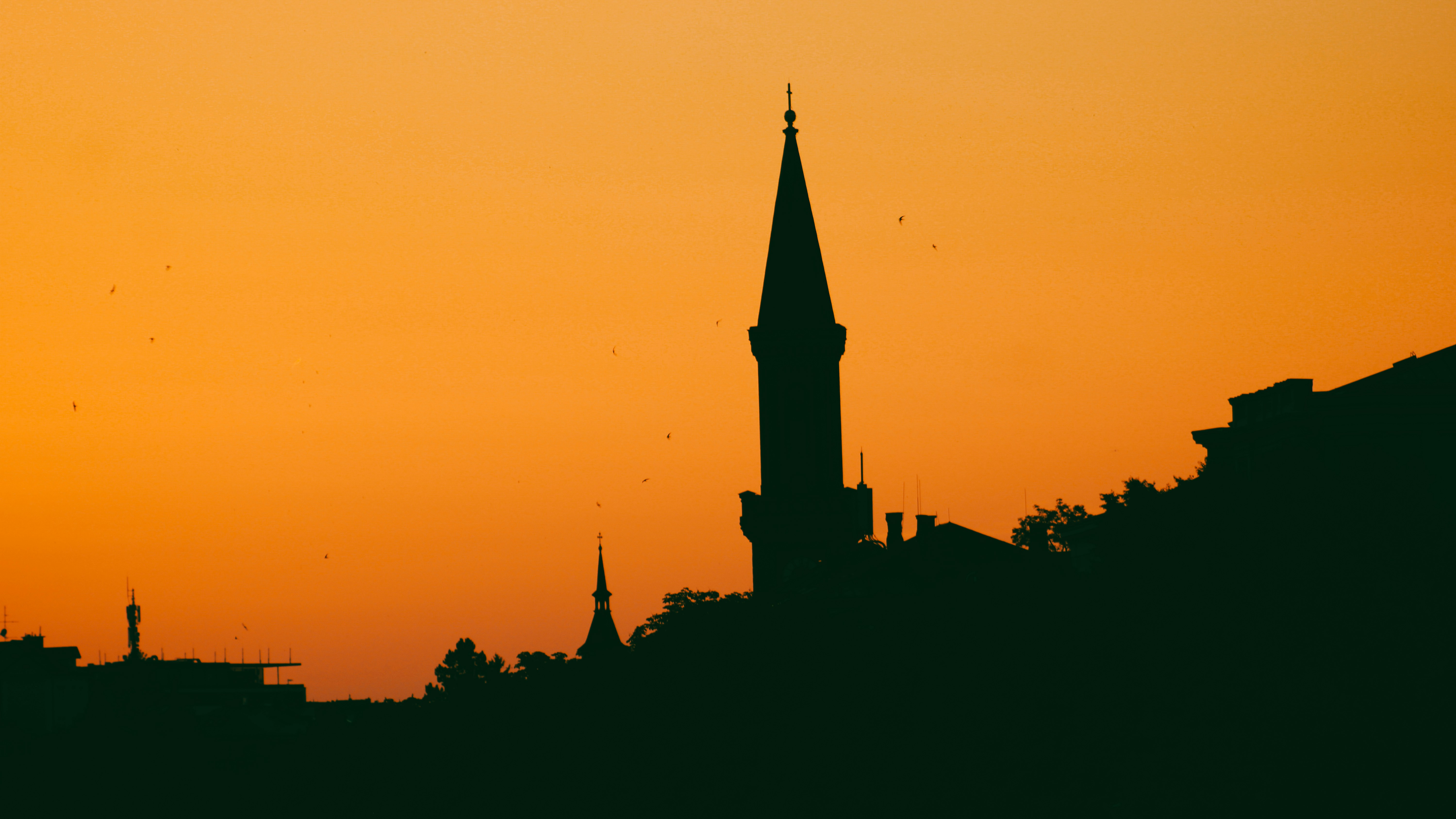 Dusk Silhouette: City Spire against an Amber Sky