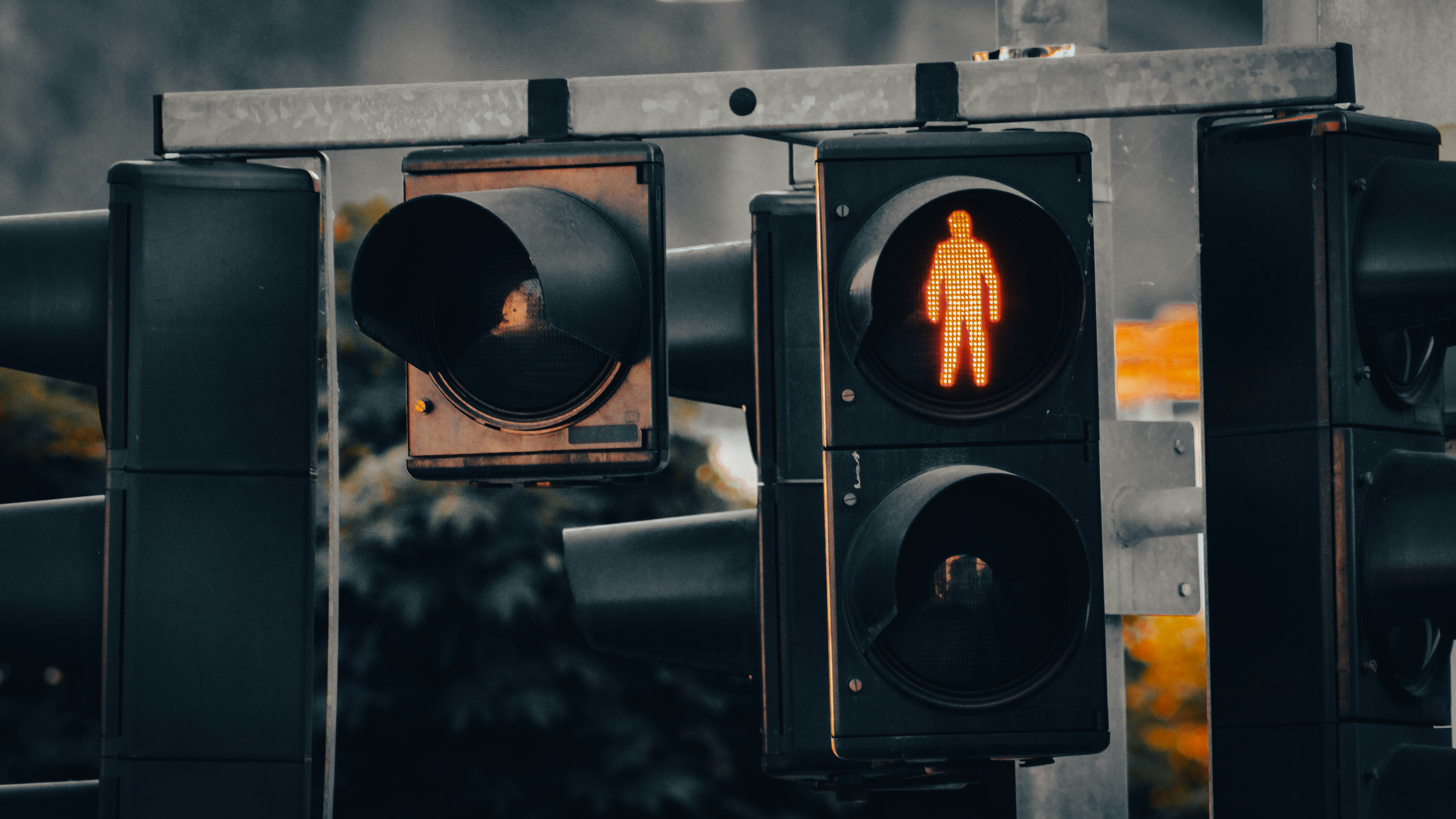 A pedestrian traffic light showing a red don't walk signal.