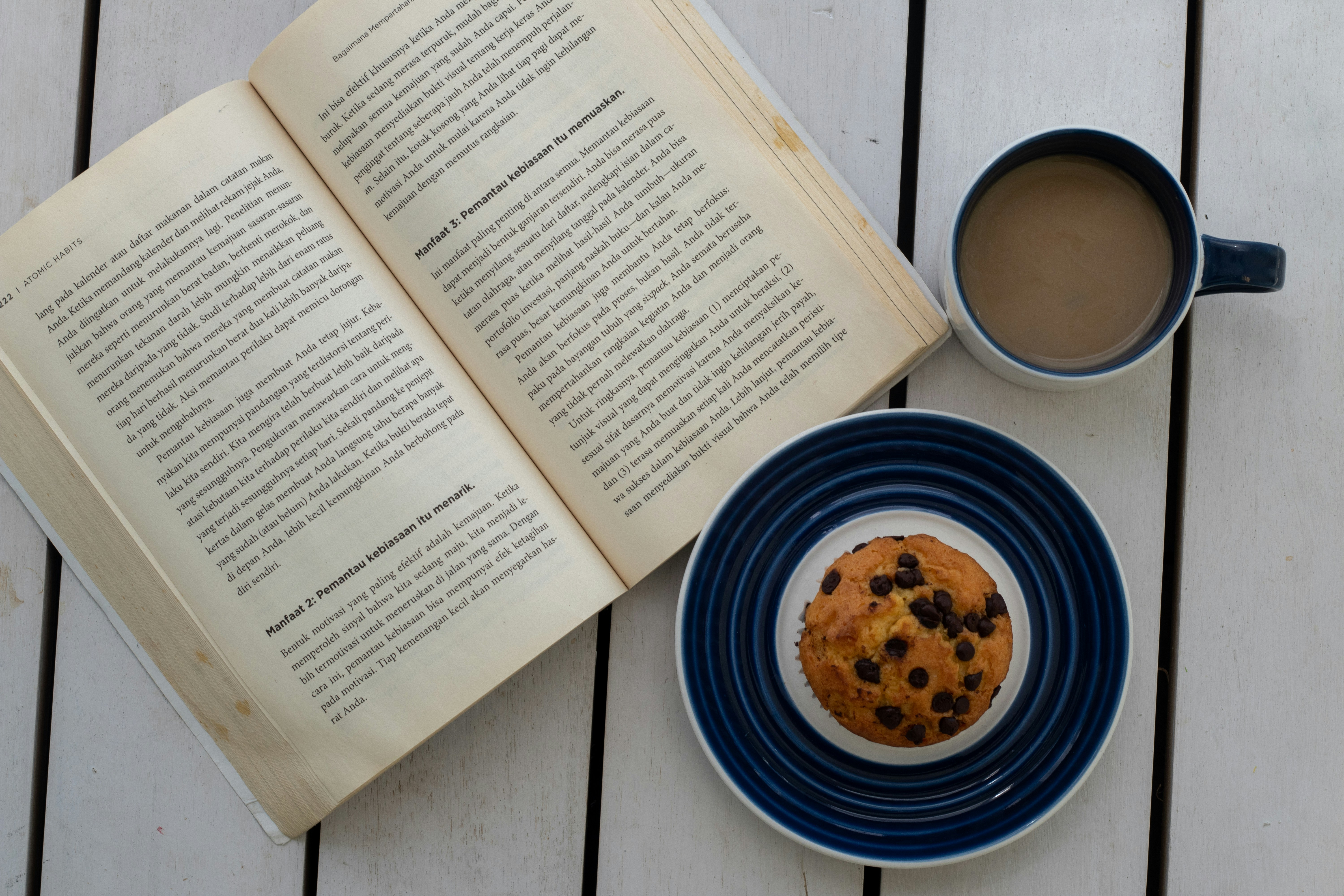 Quiet Break: A Cup of Coffee and a Cookie Beside an Open Book