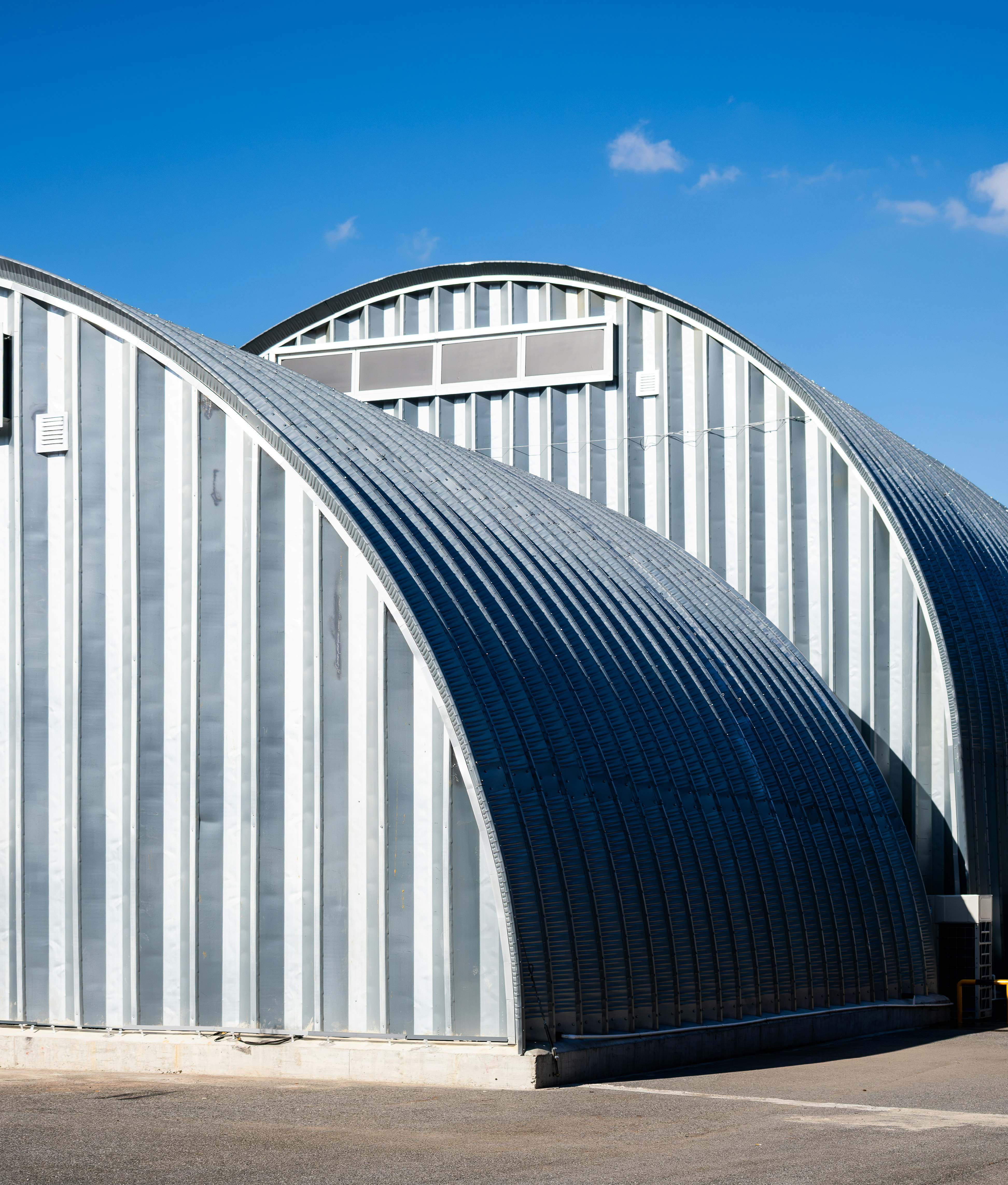 Curved Aluminum Atria: Repetition and Light on a Sunny Day