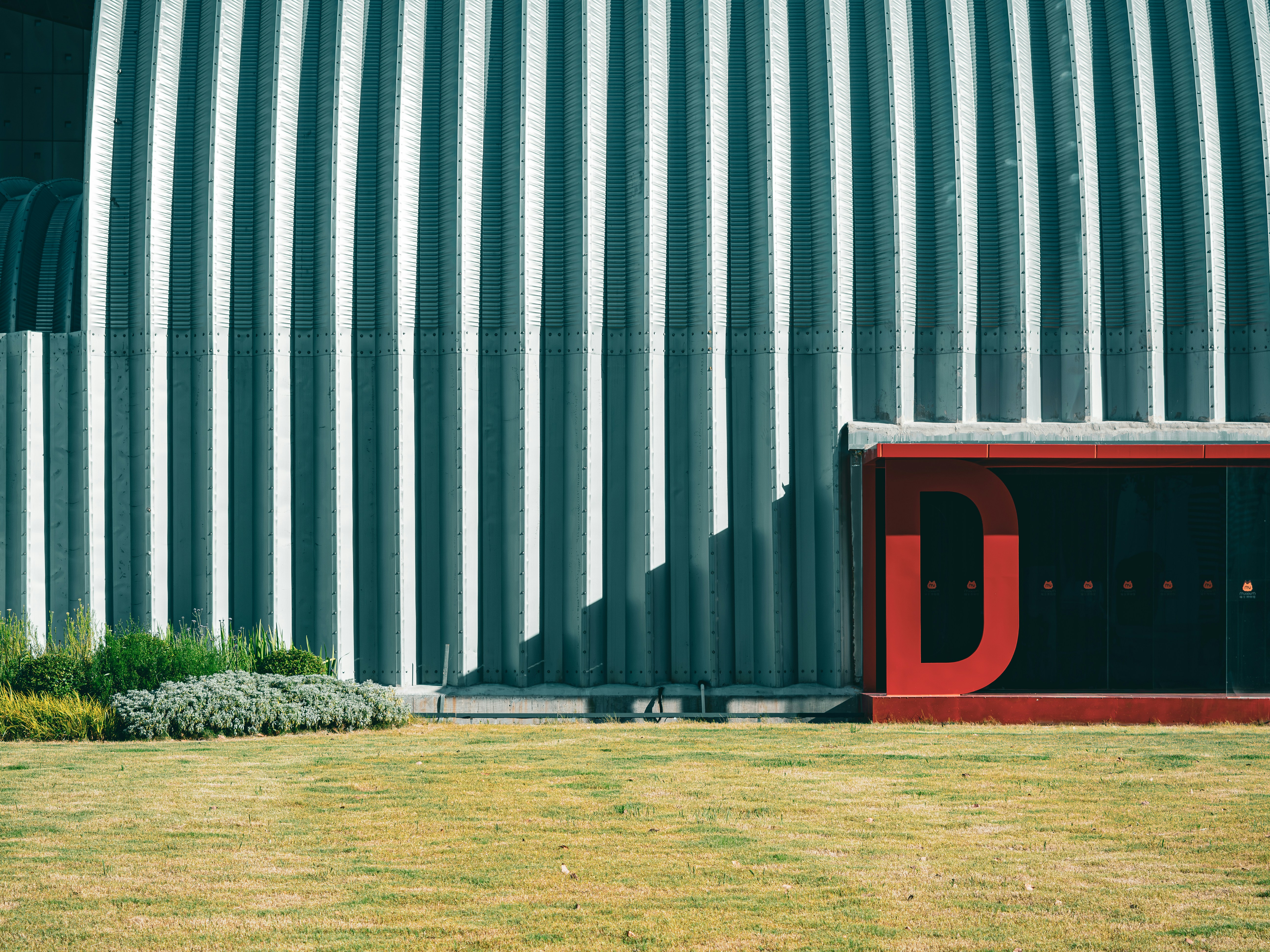 Vertical Facade and Red Door: Geometry of Modern Architecture