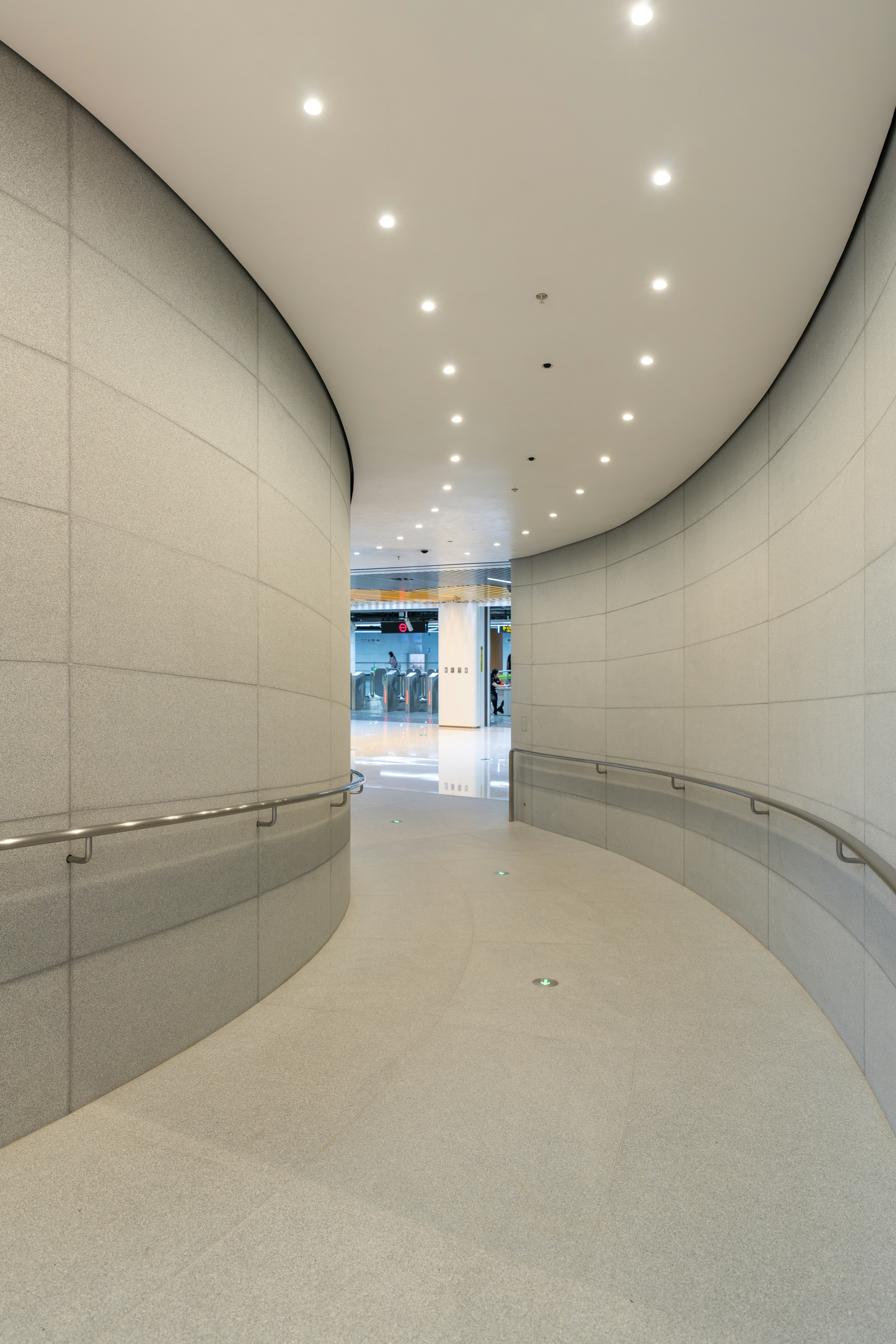 Curved Corridor to Light: A Gentle Descent into the Mall Atrium