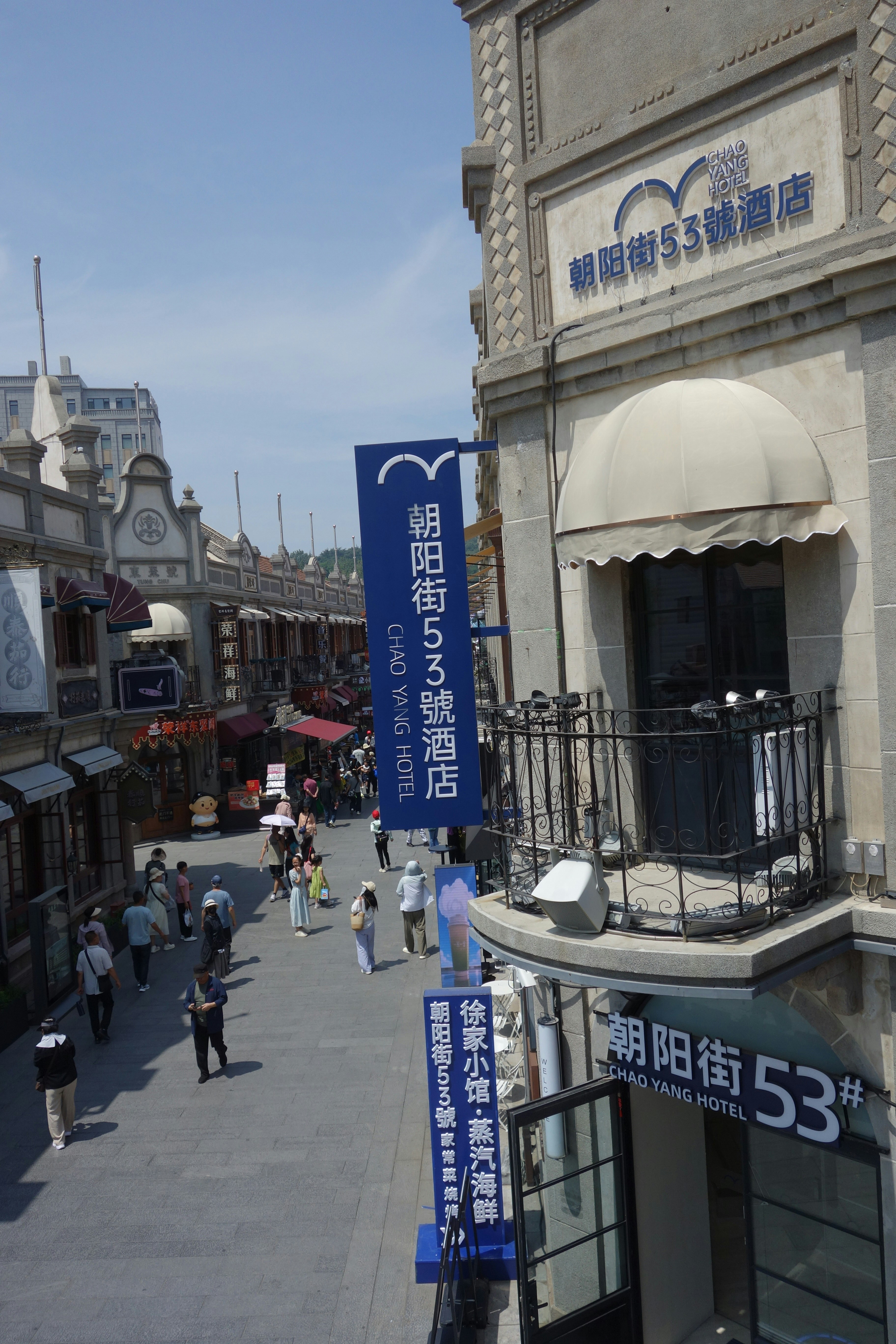 Blue Chinatown Lane: Signage, Hotel, and Pedestrian Rhythm