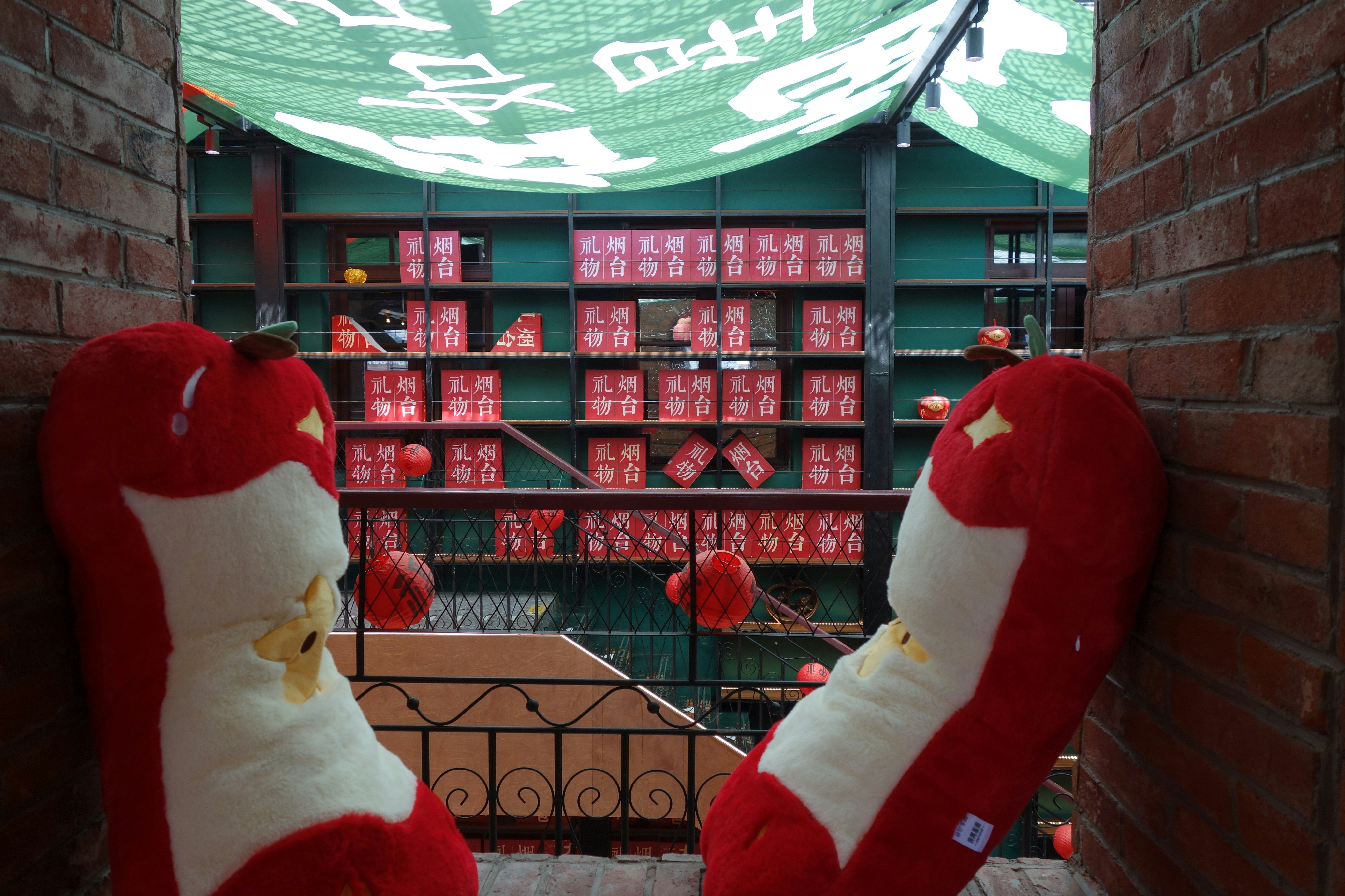 Two Red-Crowned Plush Guards Keep Watch Over Lantern-Lined Courtyard