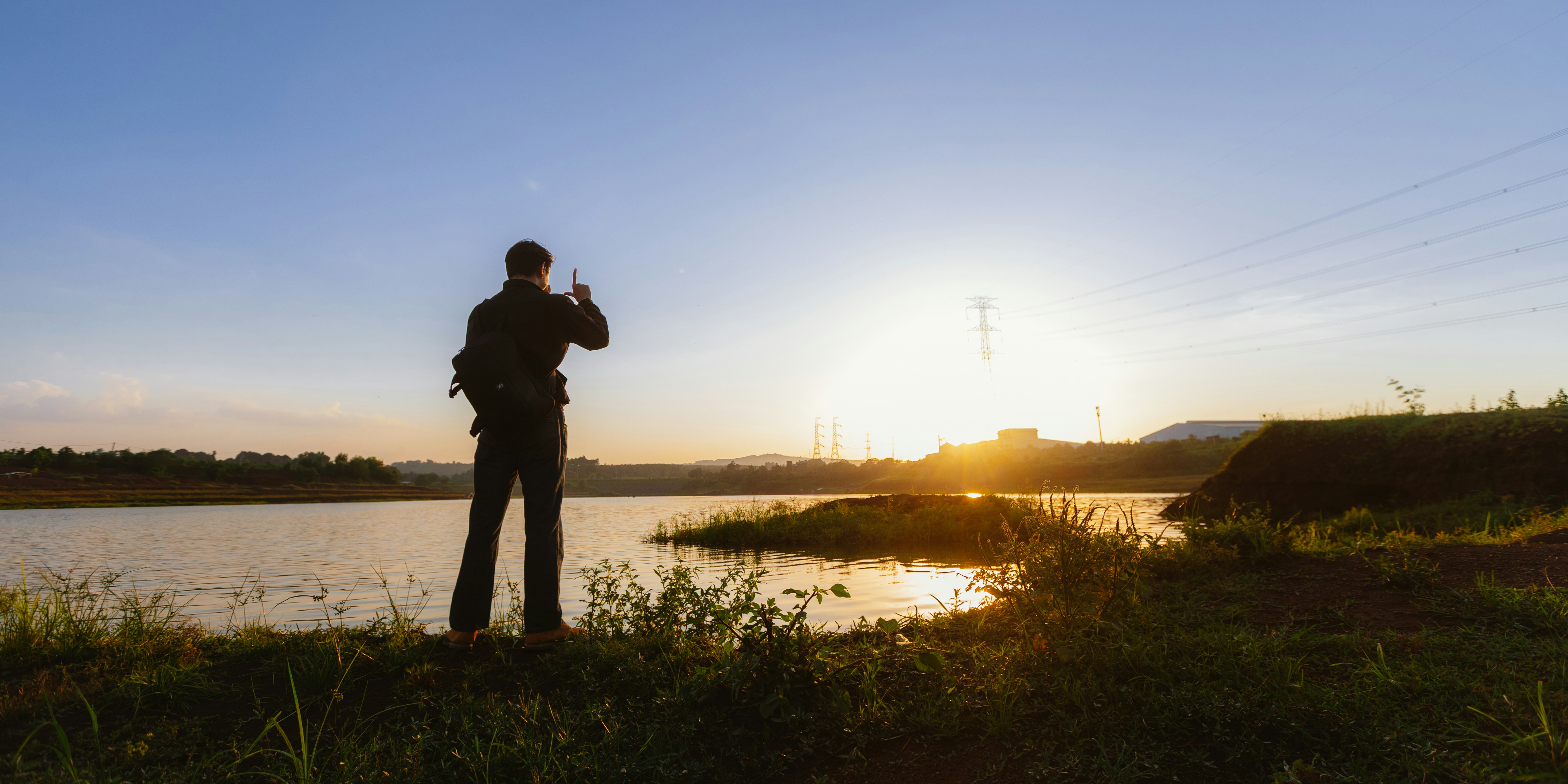 Silhouette at Sunset: A Photographer Captures Light Over Quiet Waters