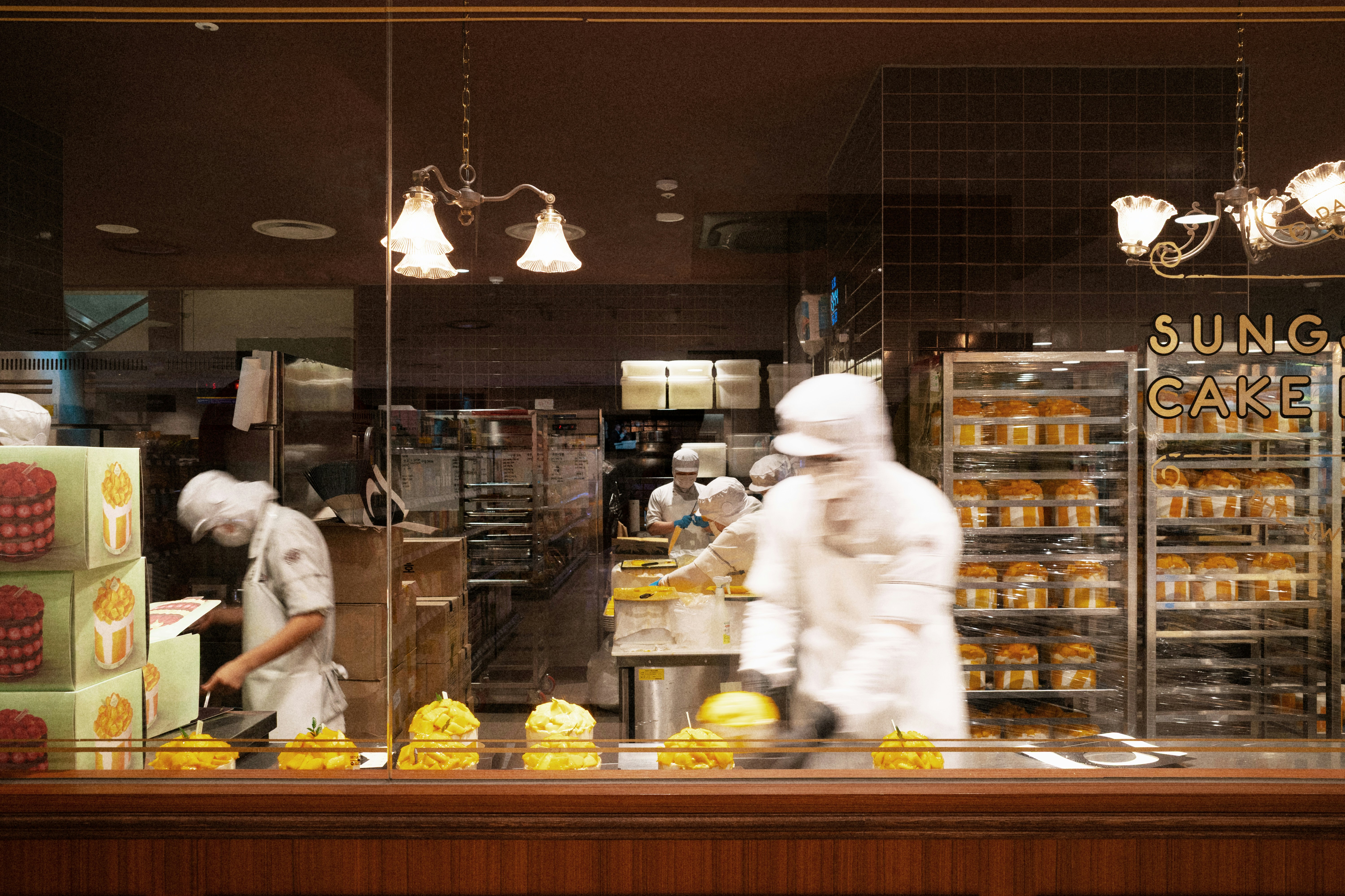 Arrival at the Pastry Window: Chefs in Motion Behind Glass