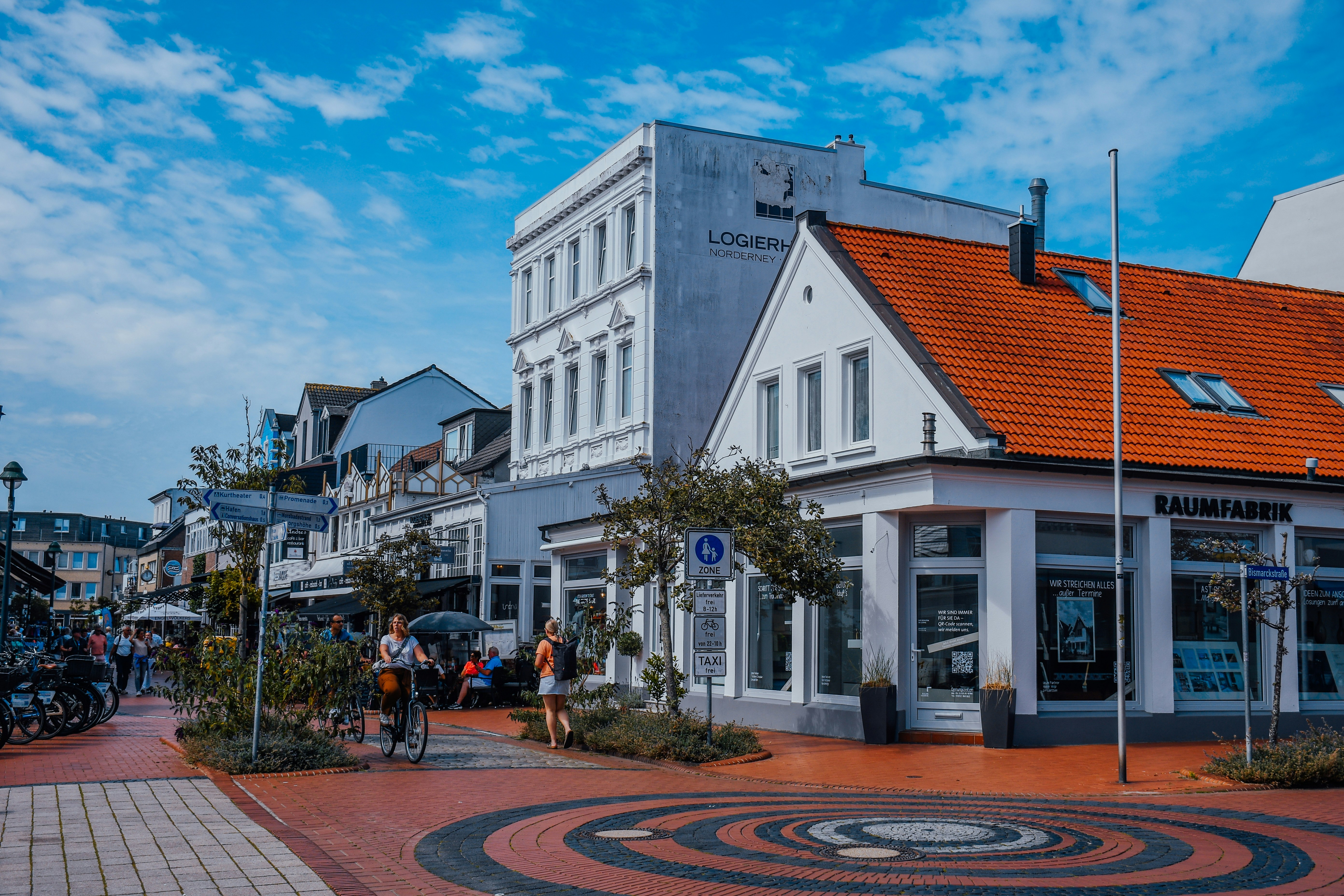 Sunlit Street Corner with White Facades and Orange Roofs