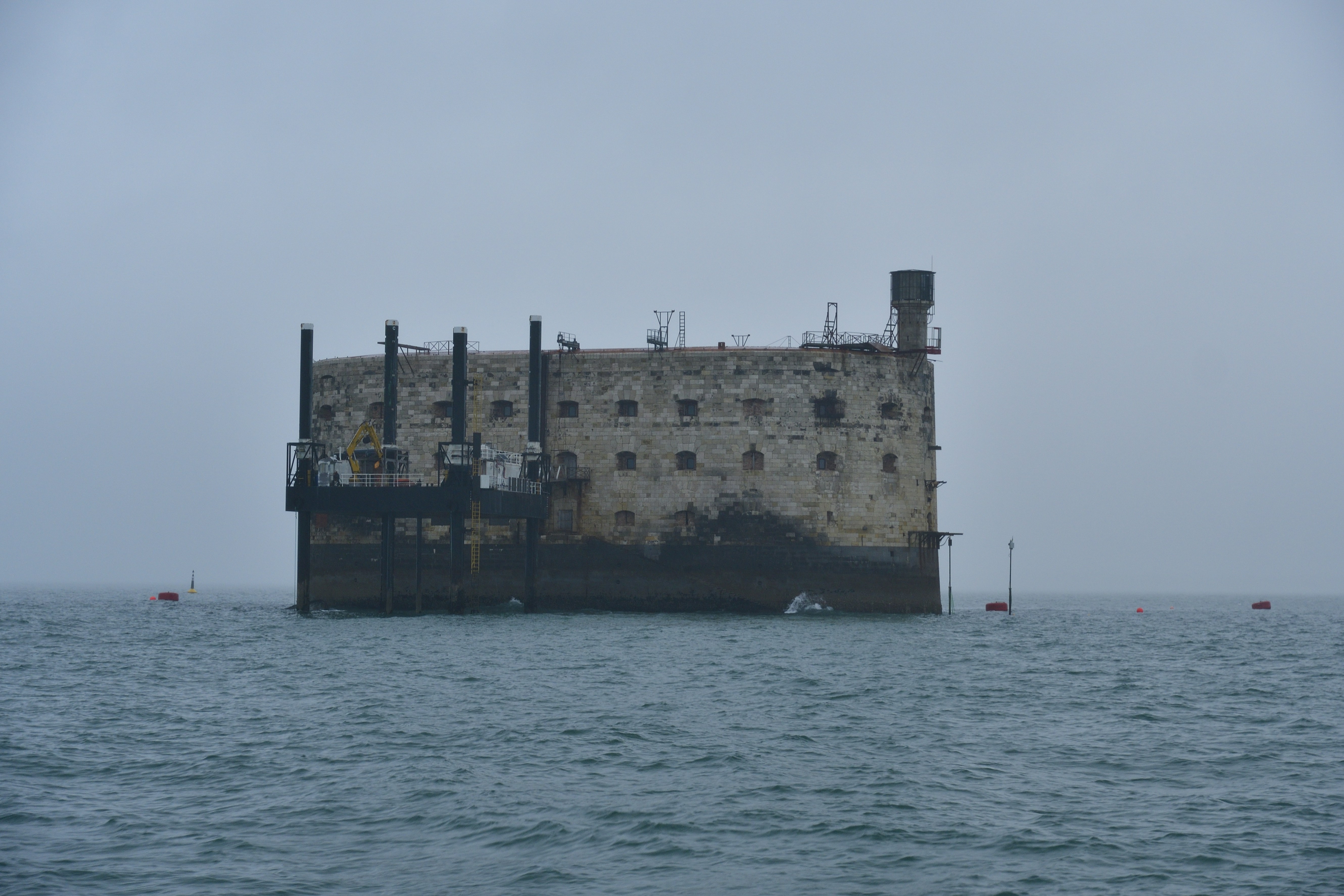 Isolated Seafront Structure: A Weathered Outpost Rising from Calm Waters