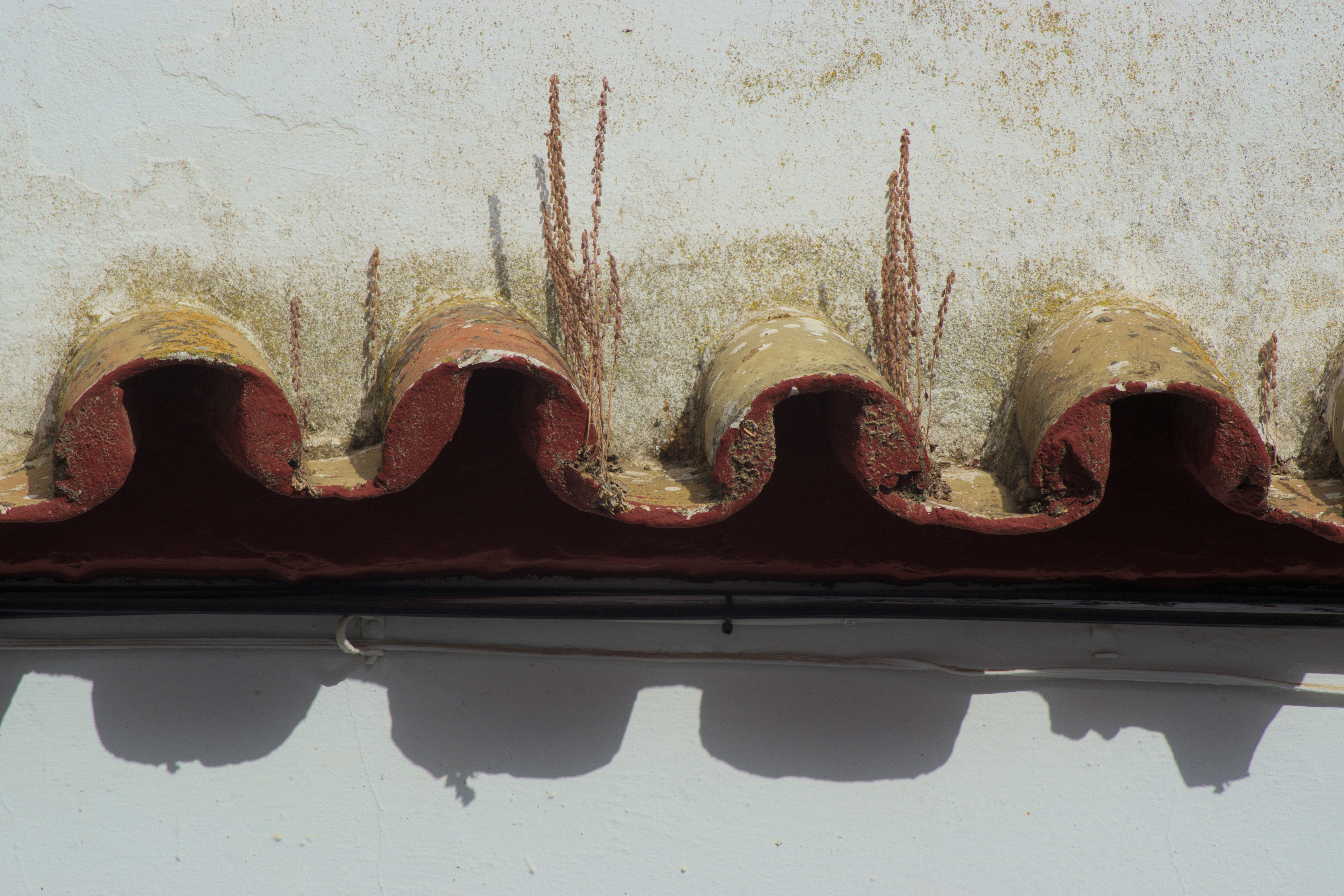 Terracotta Wave: A Weathered Roof Frame
