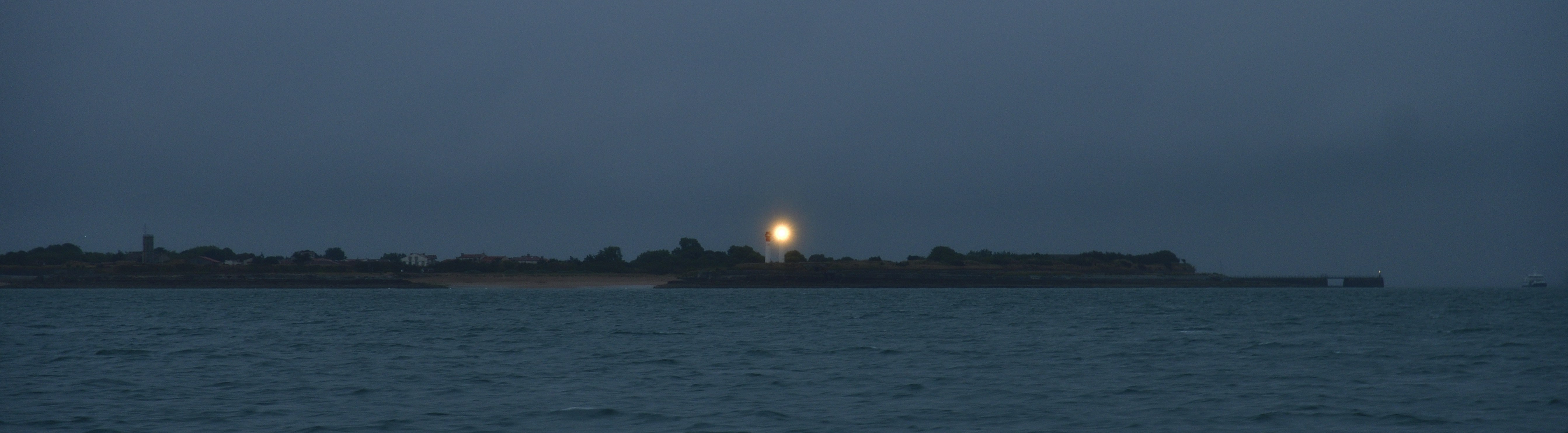Distant Lighthouse Crescent: Moonlit Calm Over a Seabound Horizon