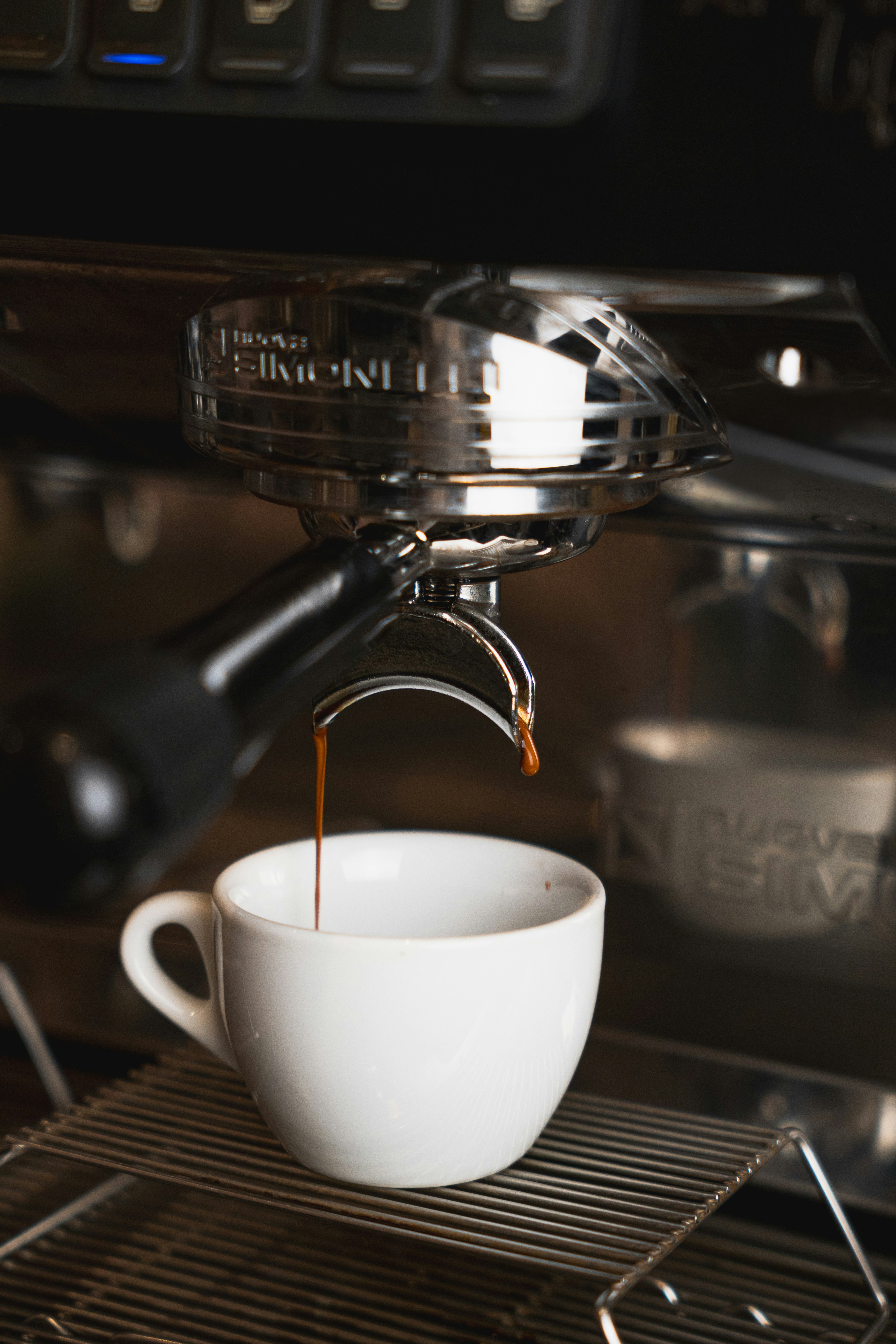 Espresso Ritual: A White Cup Embraced by a Gleaming Espresso Portafilter