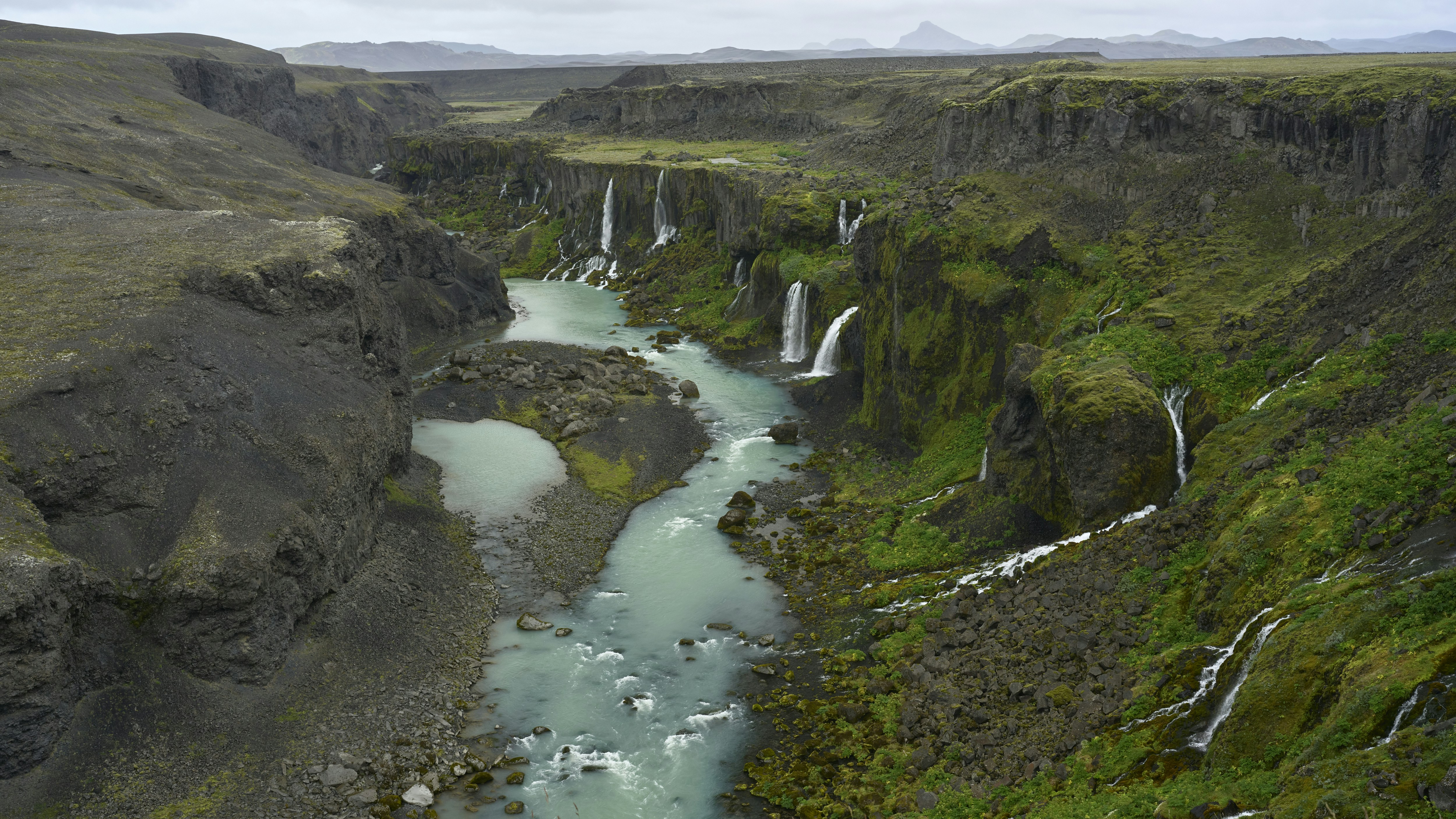 Icelandic Gullies: Turquoise River Meanders Through Mossy Cliffs