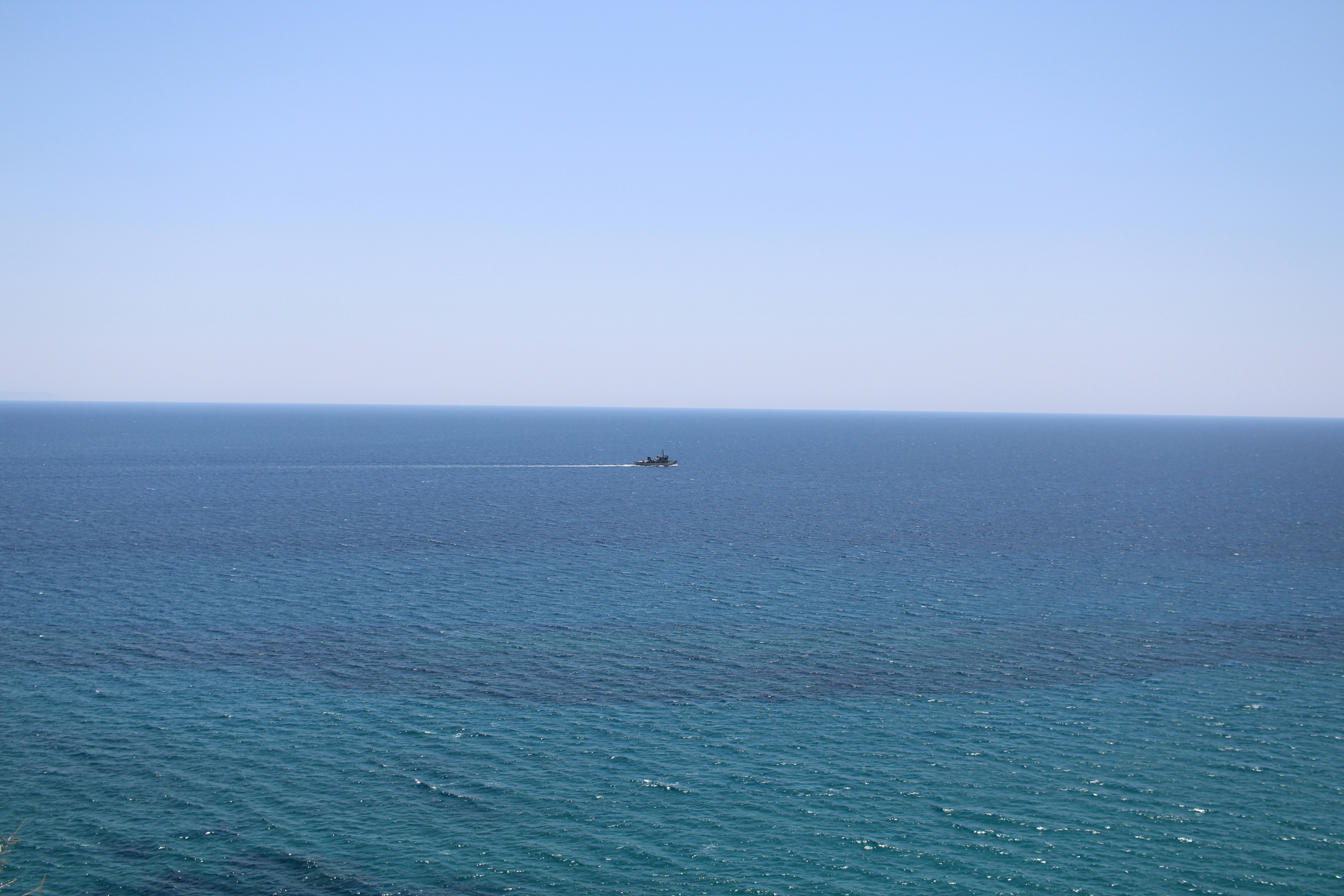 A Lone Vessel Tracing a Quiet Horizon