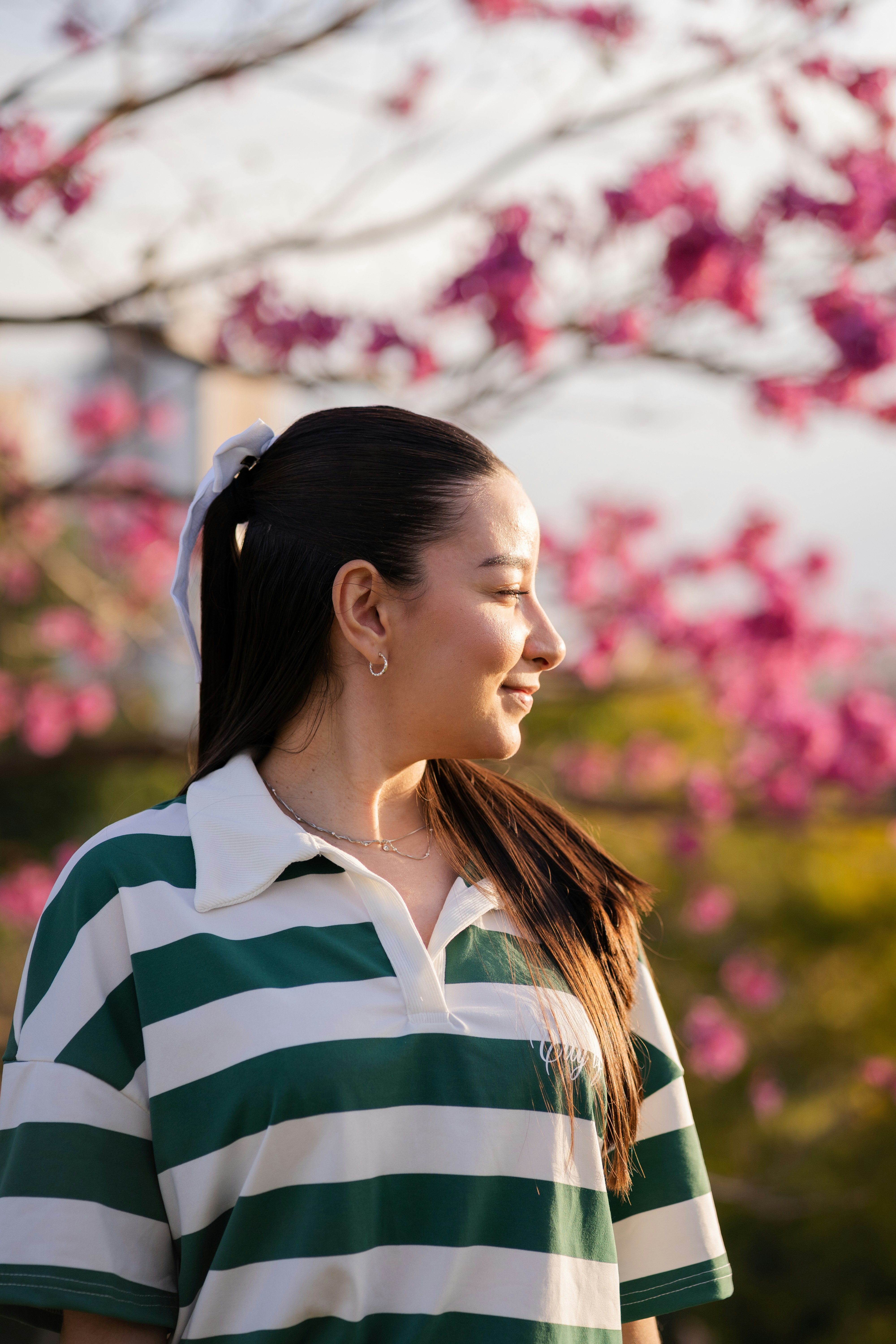 Portrait in Bloom: A Side Glance Among Pink Blossoms
