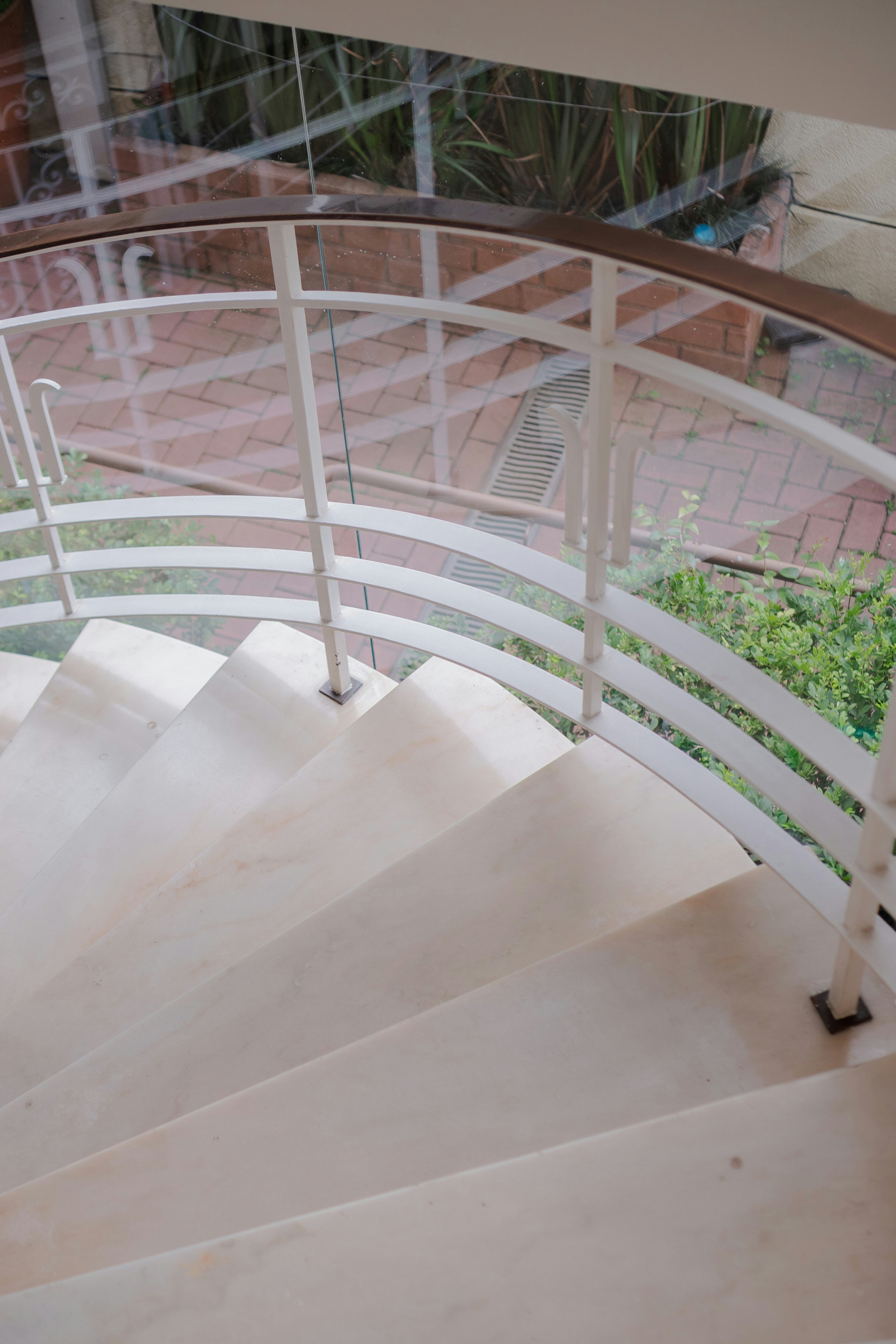 Spiral Staircase Arc: Marble Steps Meeting a Glass Window