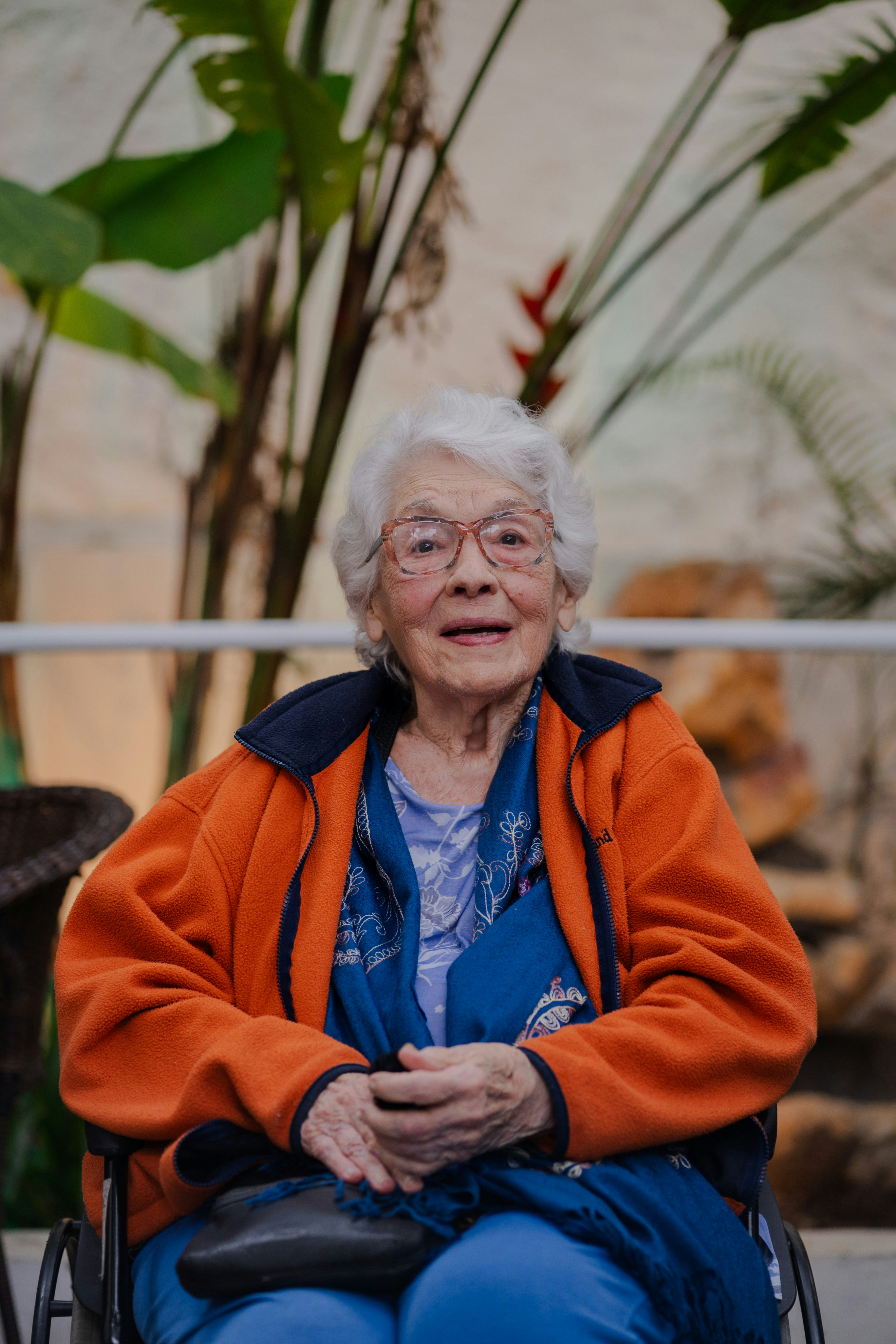 Gentle Grace: Elderly Woman in a Bright Orange Jacket