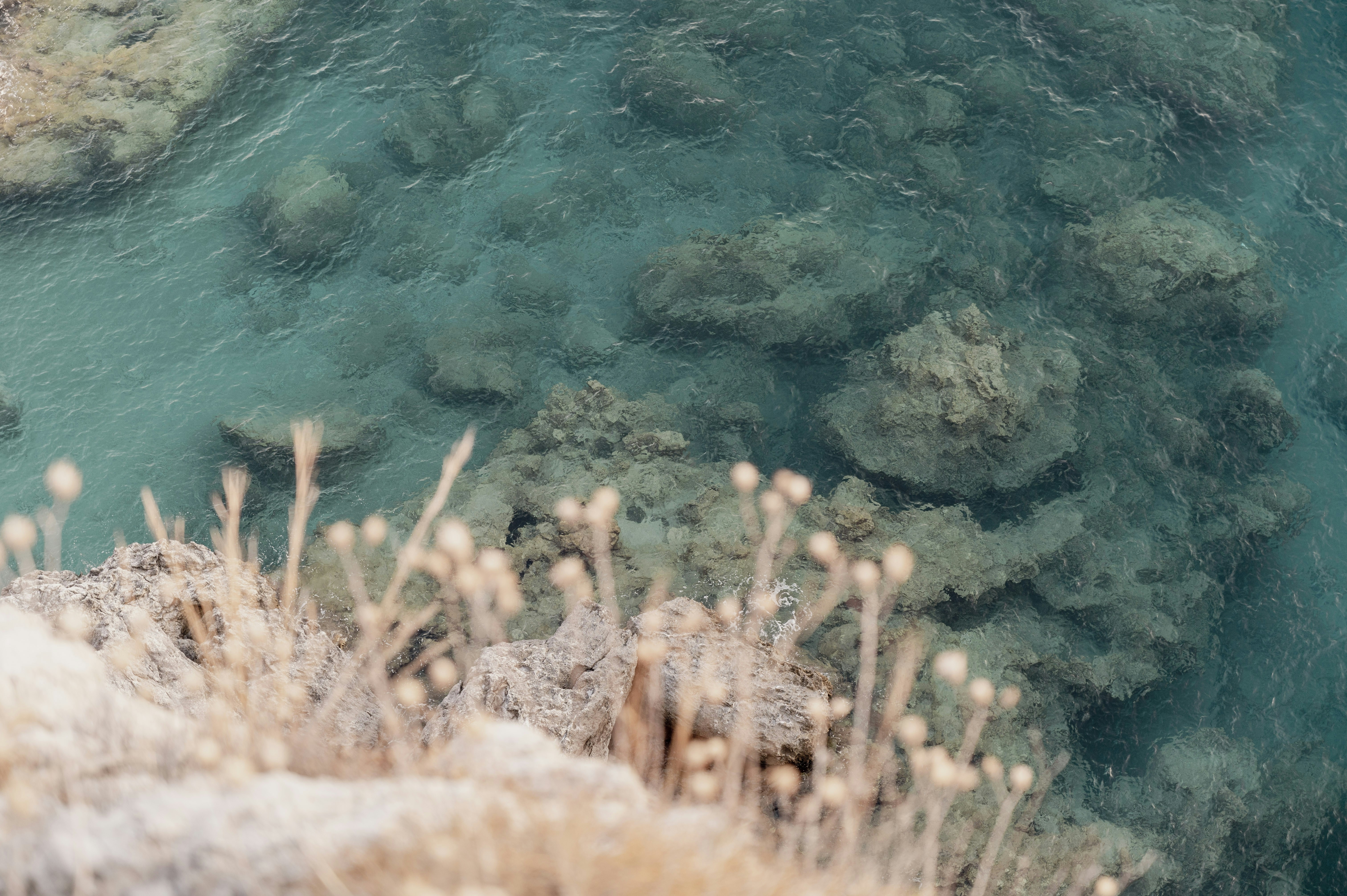 Turquoise Depths Beneath Weathered Cliffs