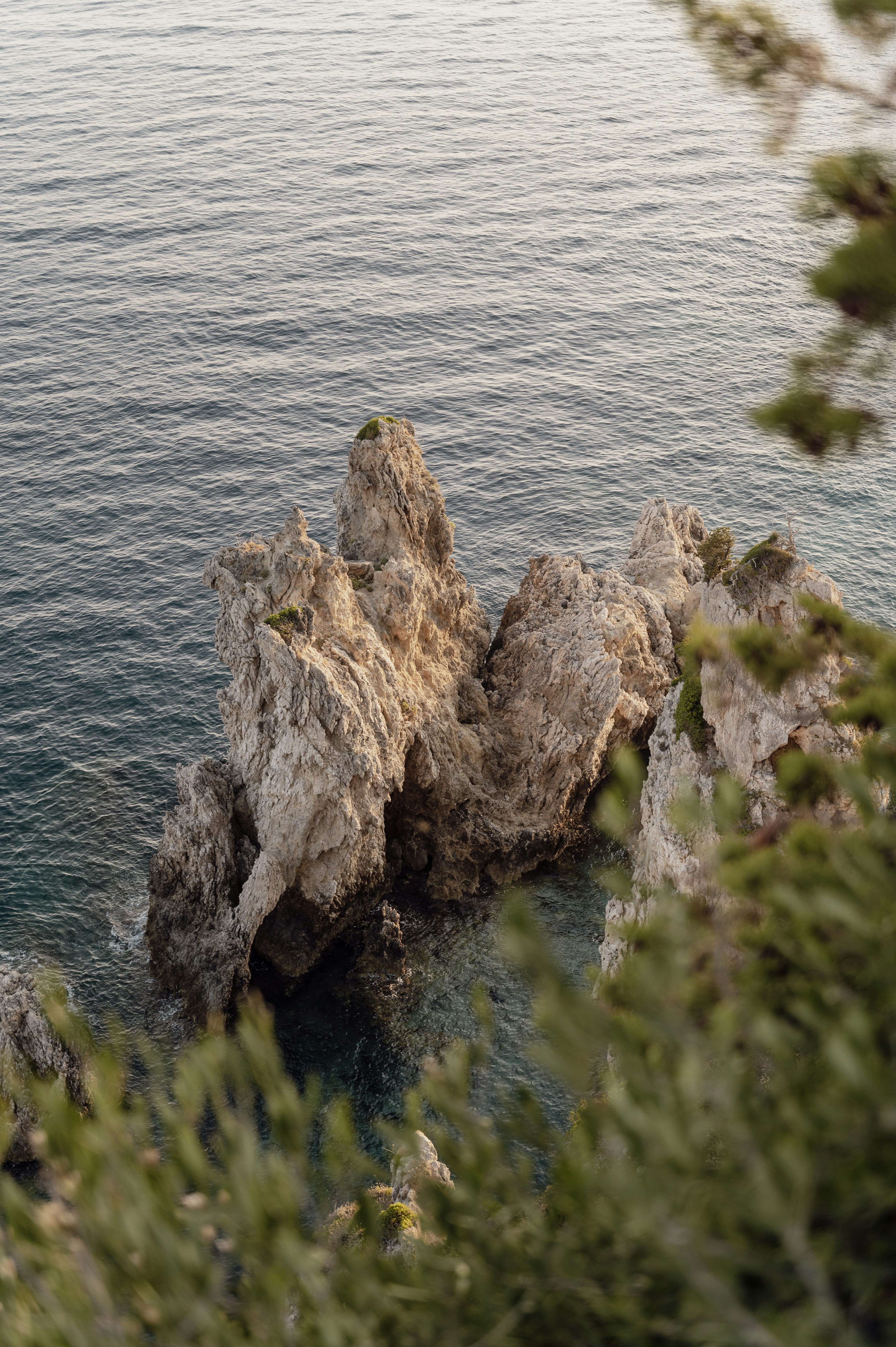 Sea Stack Sentinel: Rugged Rock Formations Steadfast Over Quiet Waters