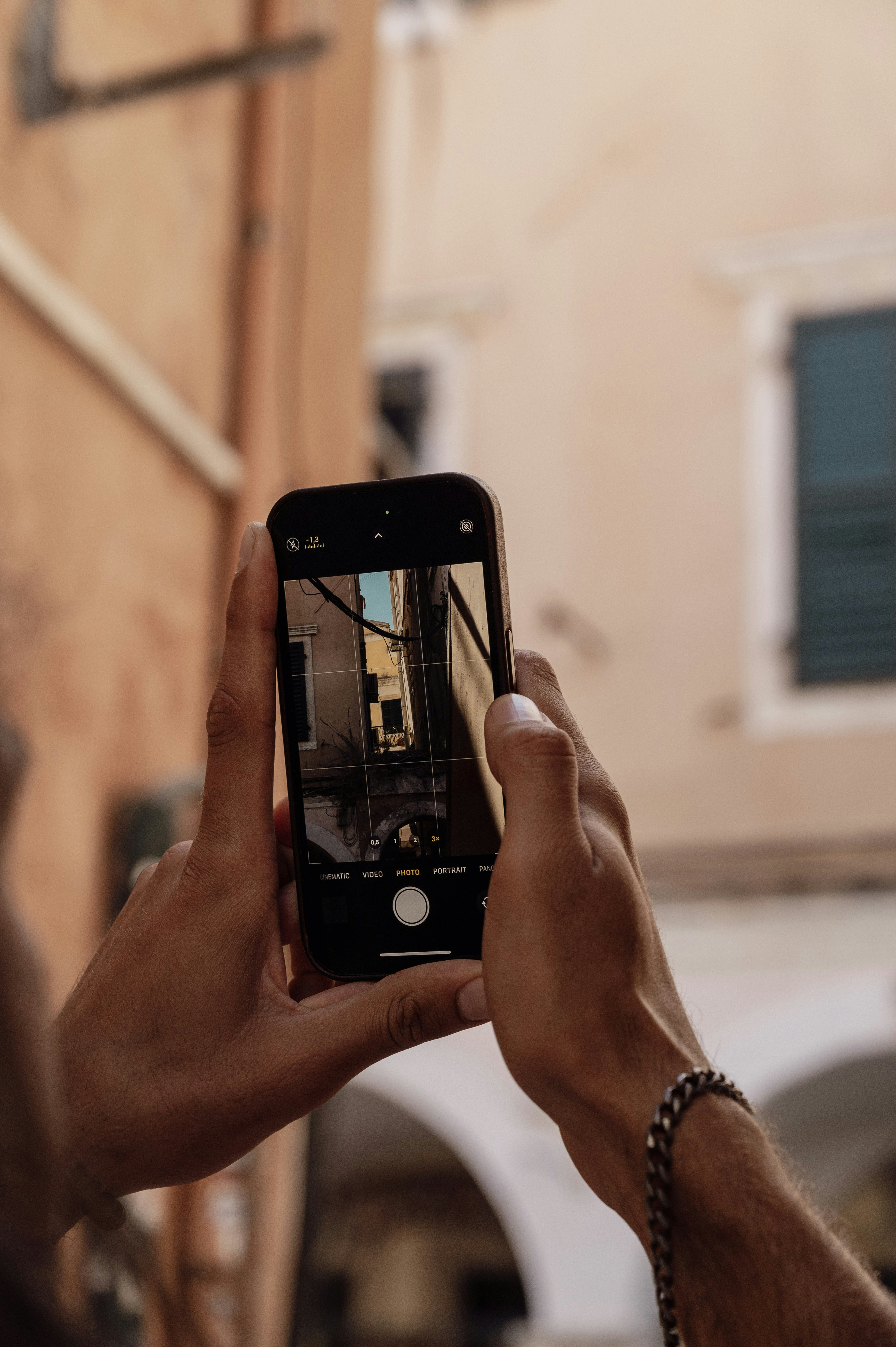 Holding the Frame: A Street-Window Snapshot Through a Phone