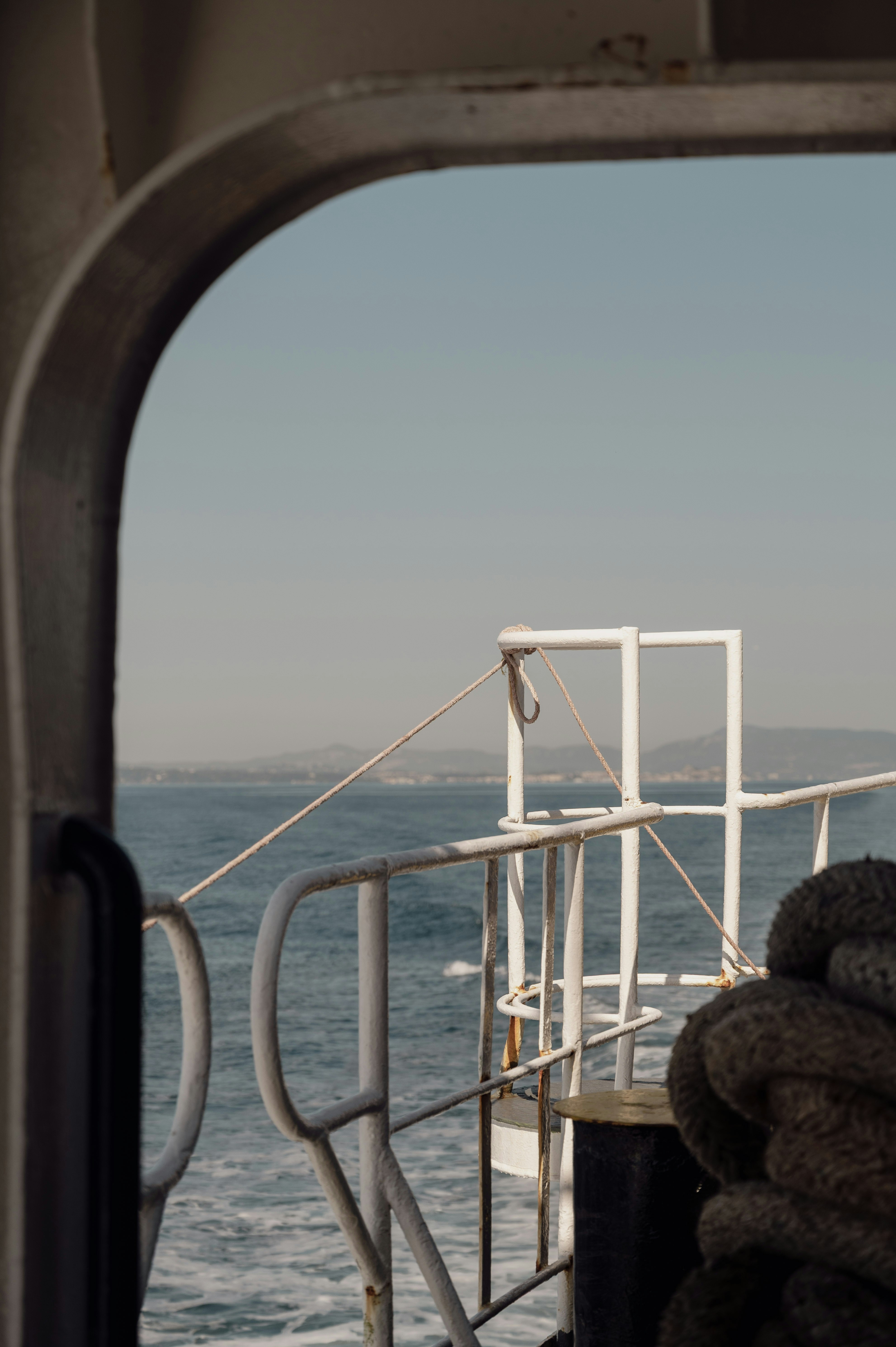 Framing the Sea: A Wheelhouse View Beyond the Rail