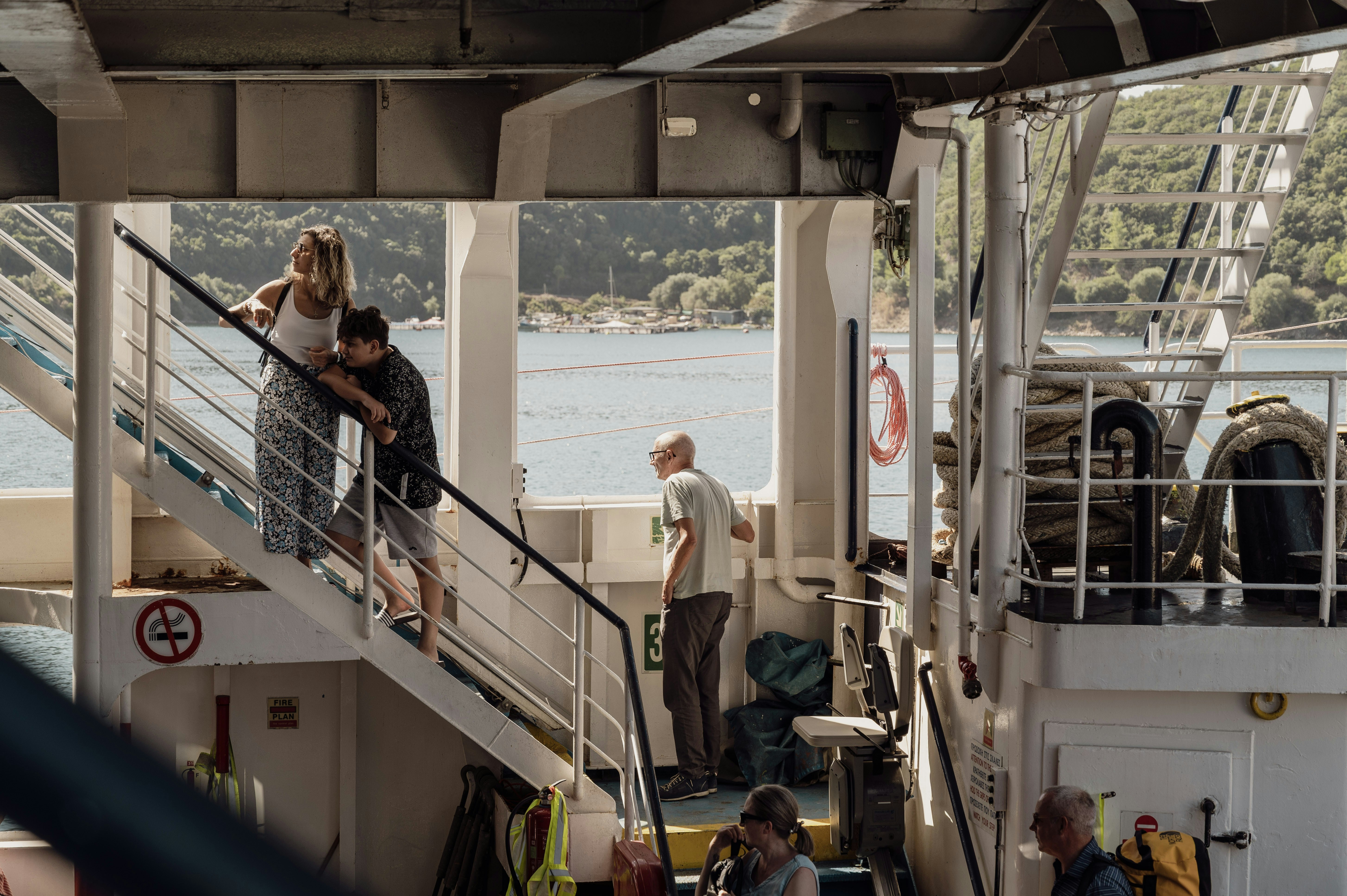 Leaving the Dock: Faces and Steps on a Sunlit Ferry Deck