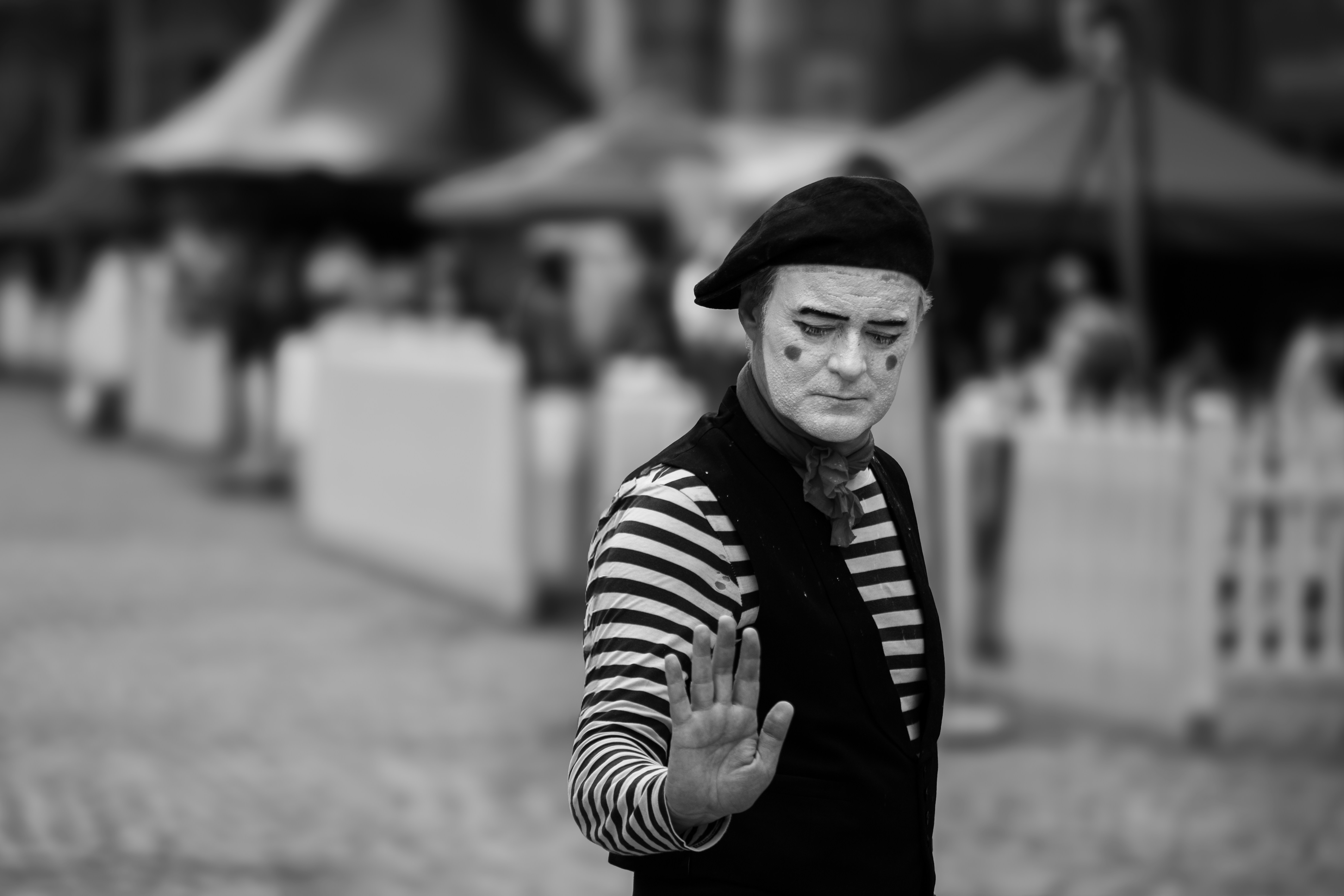 Mime in the Market: A Quiet Gesture Amid the Blur