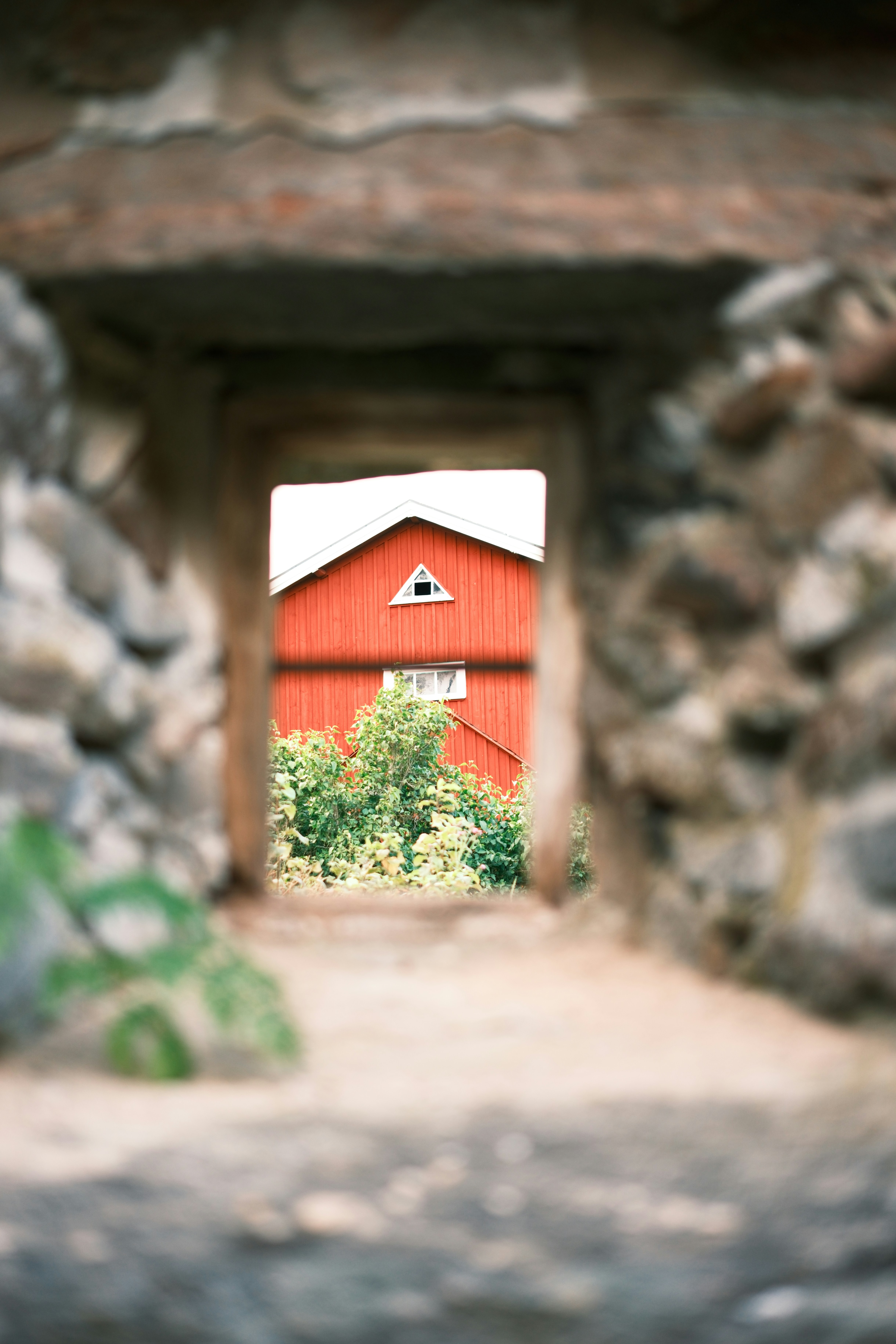 Targeted View Through the Stone Window: Red Barn in Focus