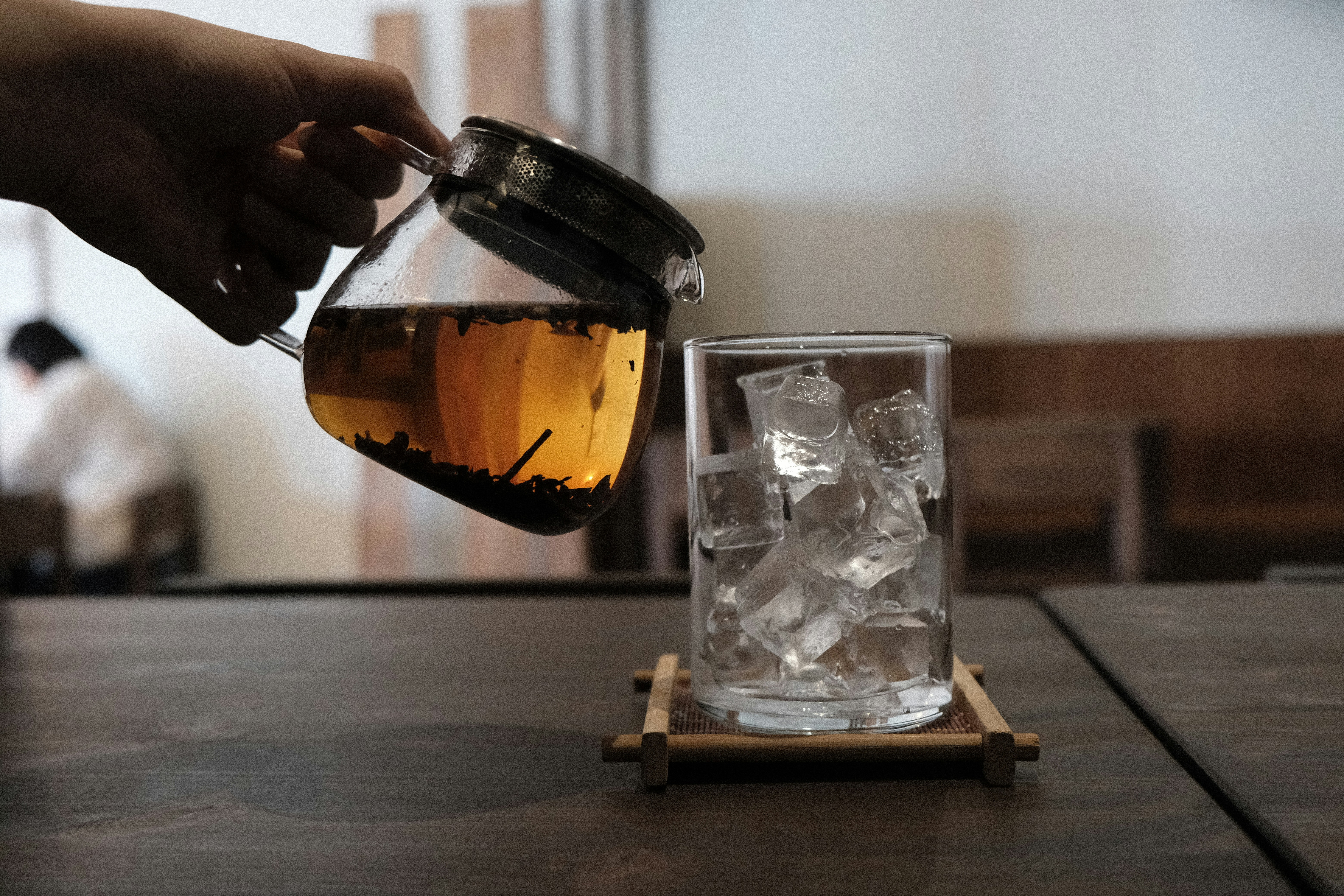 Tea Cascade: Pouring Warmth Over a Crystal Glass