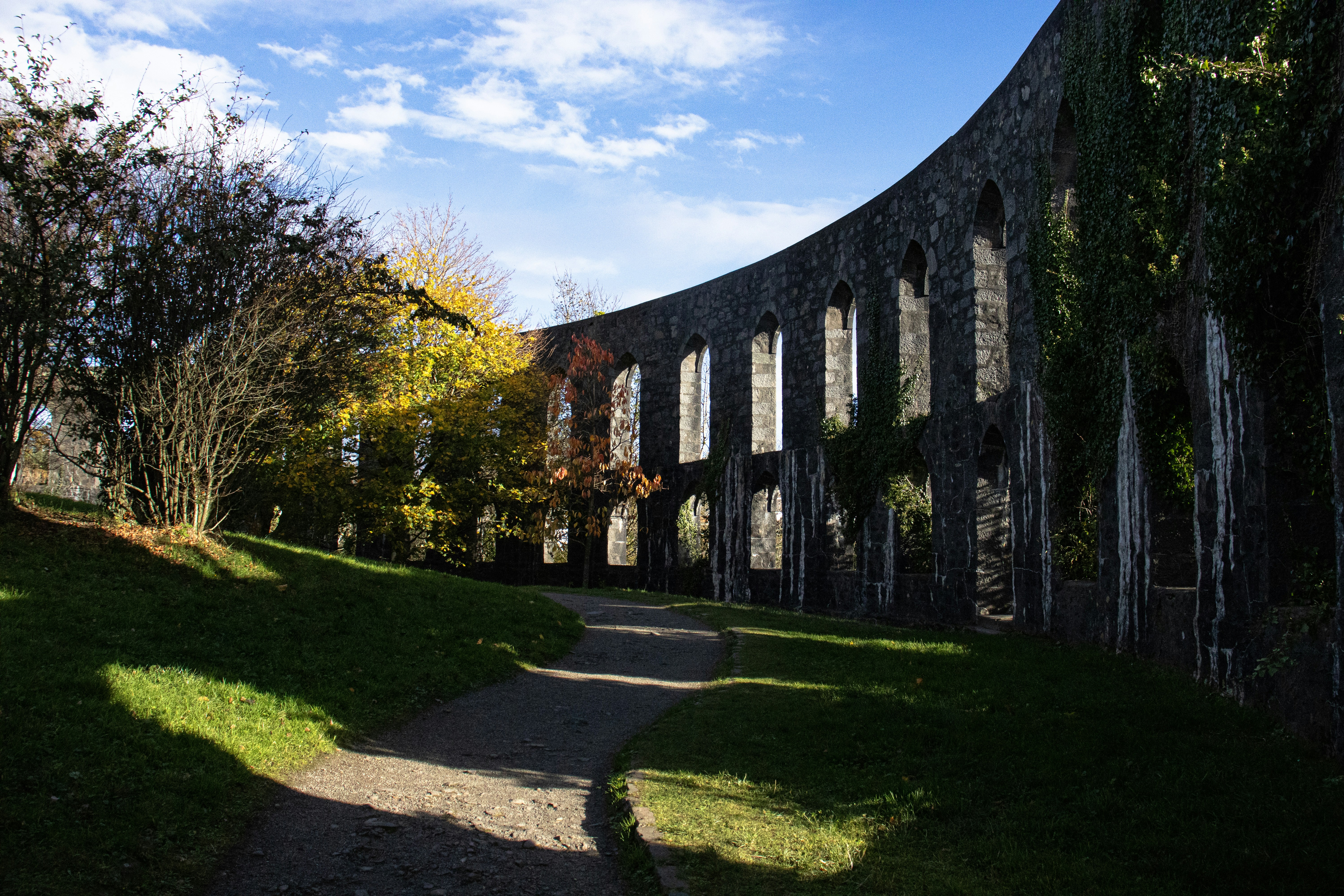 Whispering Viaduct: Sunlit Path Through Arcades