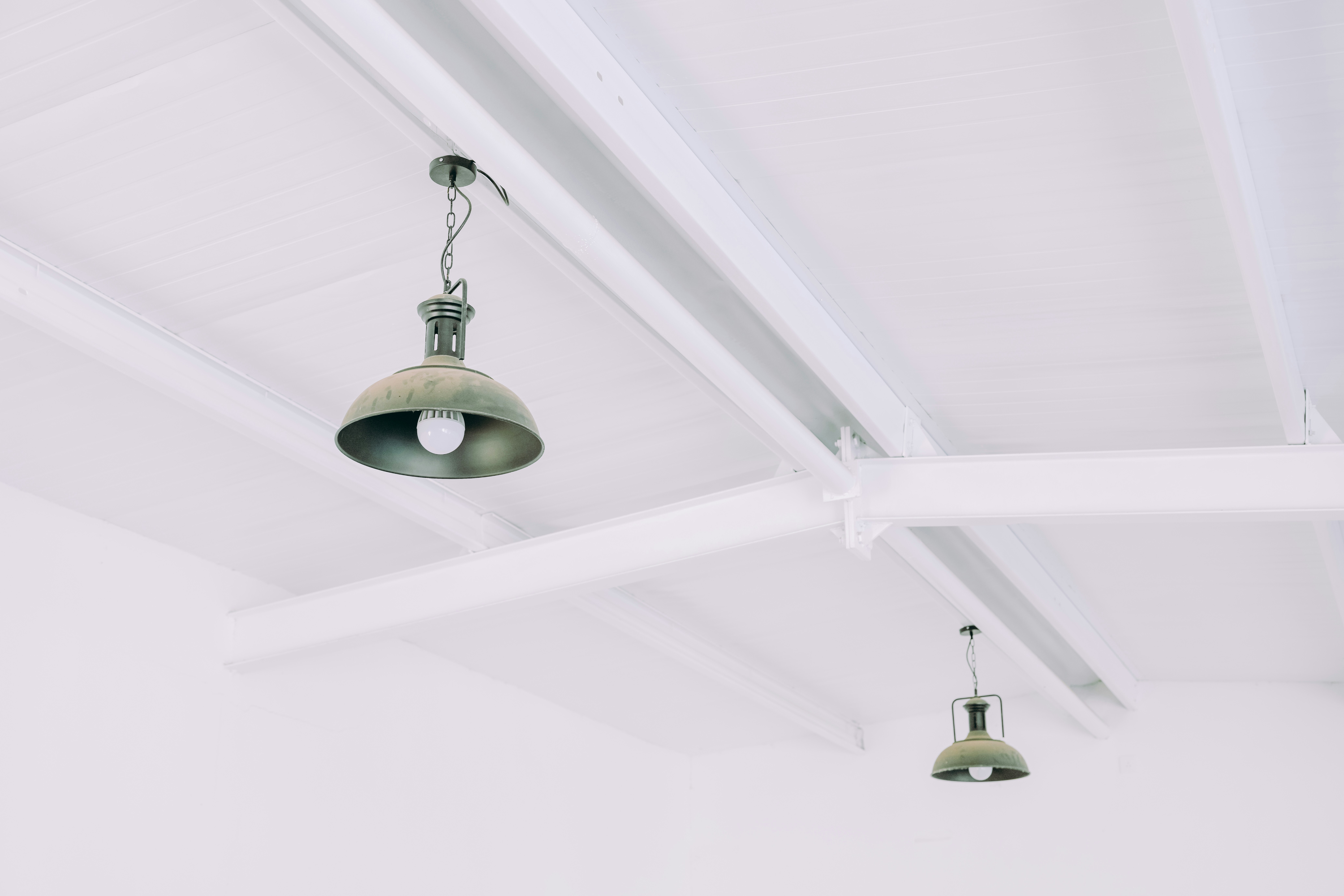 Overhead Echoes: Industrial Lamps in a Quiet White Ceiling
