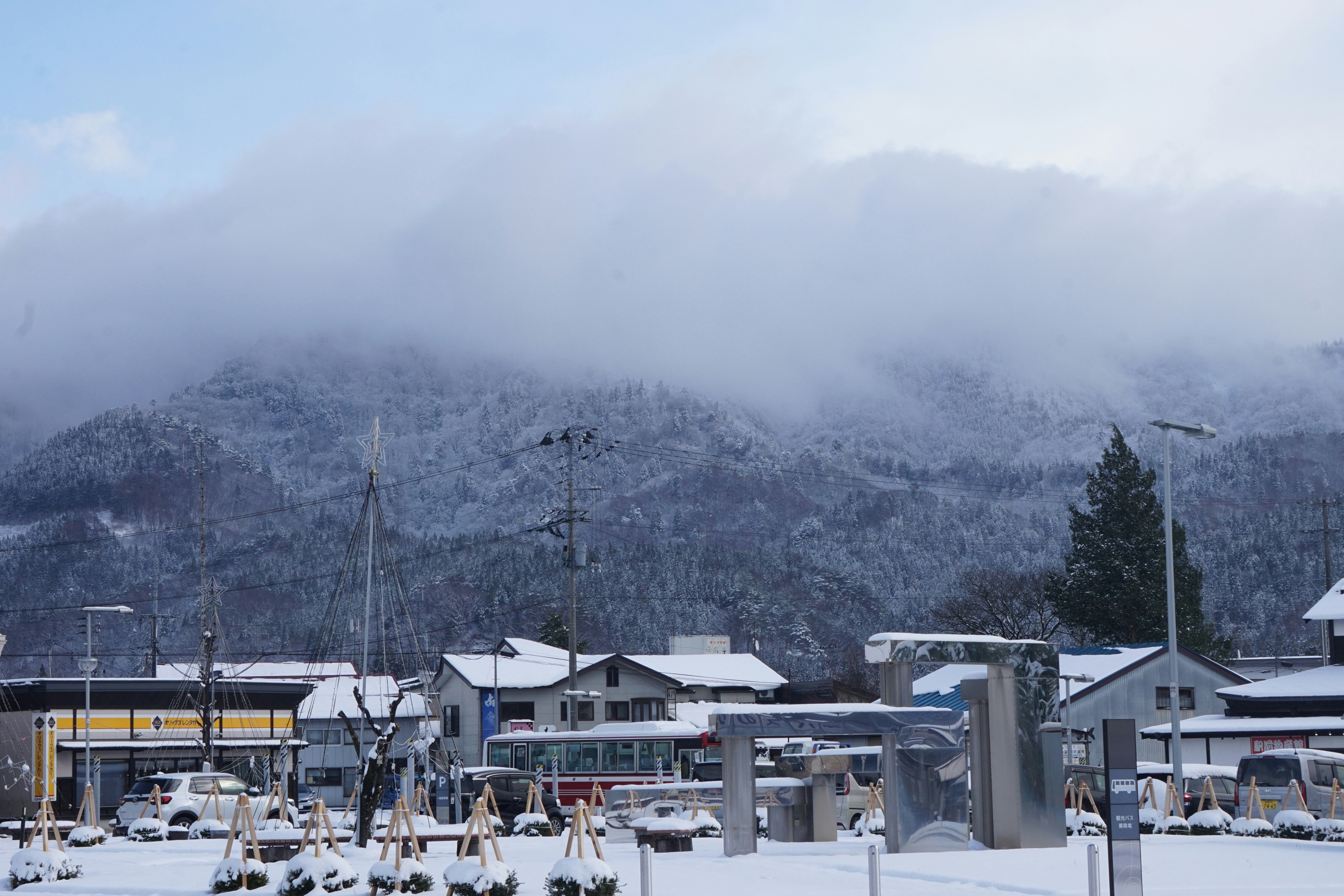 Snowbound Valley Streetlights Under Clouded Peaks