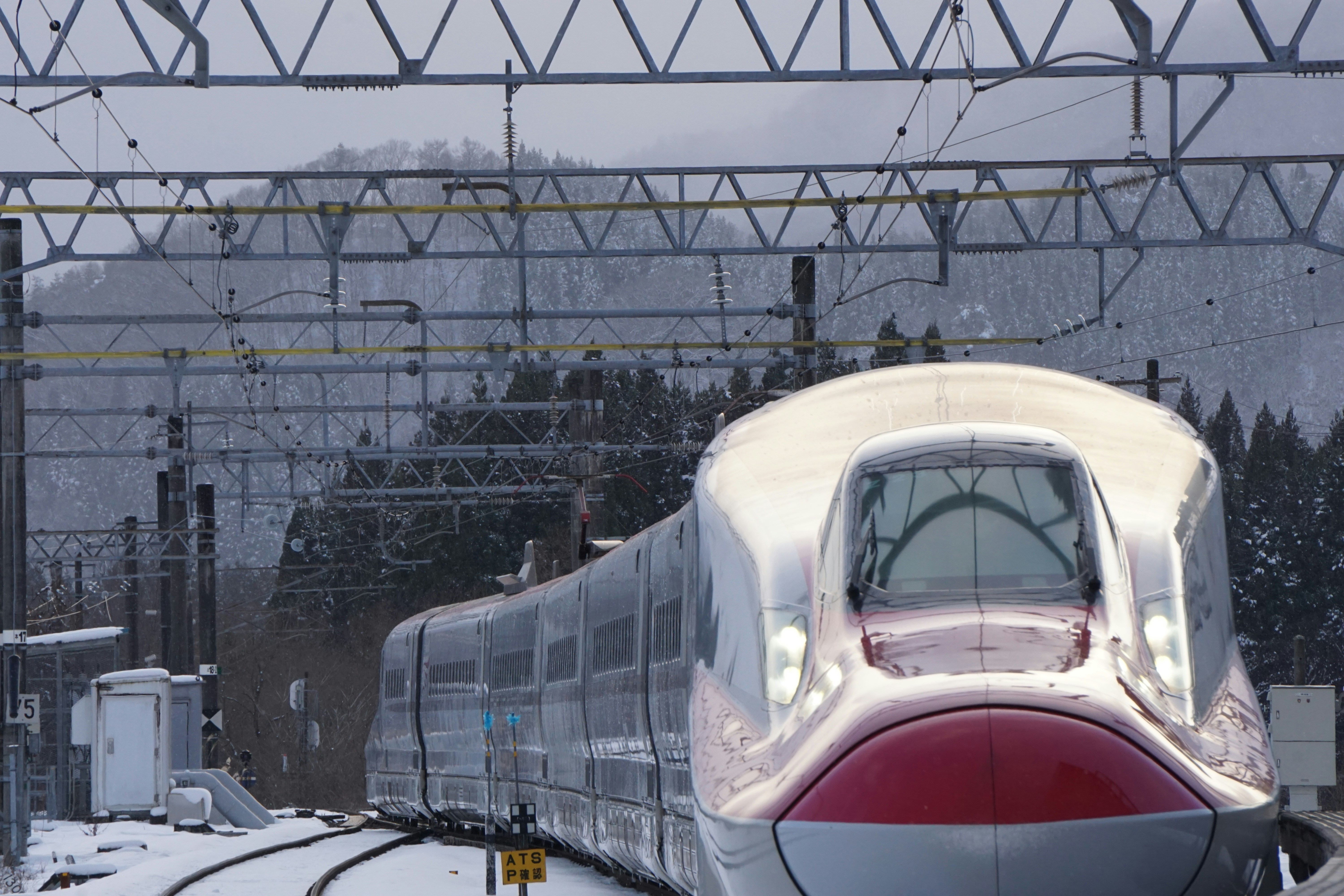 High-Speed Silent Arrival: A Shimmering Bullet Trains Amid Snow