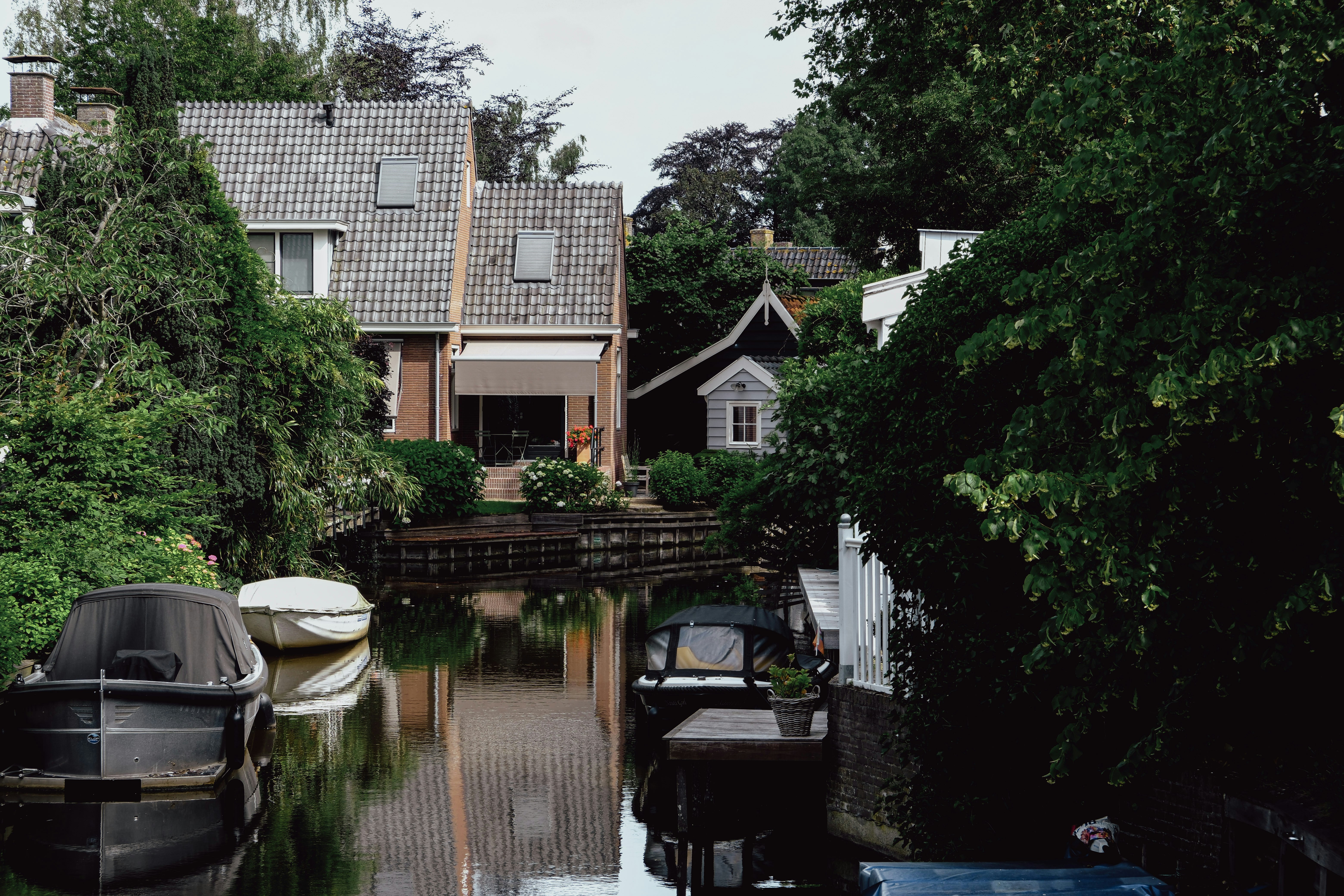 Canal Veil: Boatside Houses Reflected in Quiet Dutch Channel